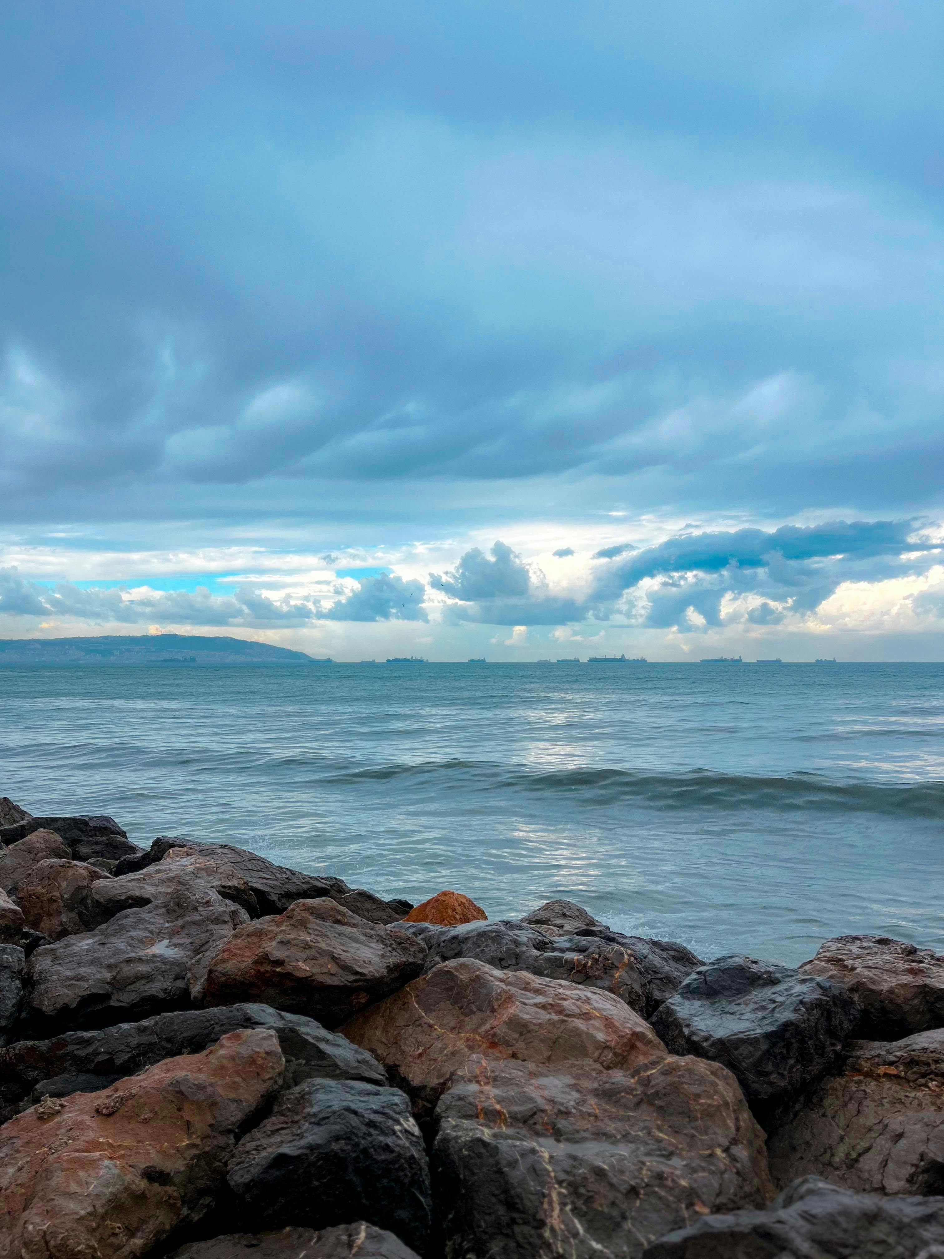 Scenic Ocean View with Dramatic Clouds and Rocks · Free Stock Photo