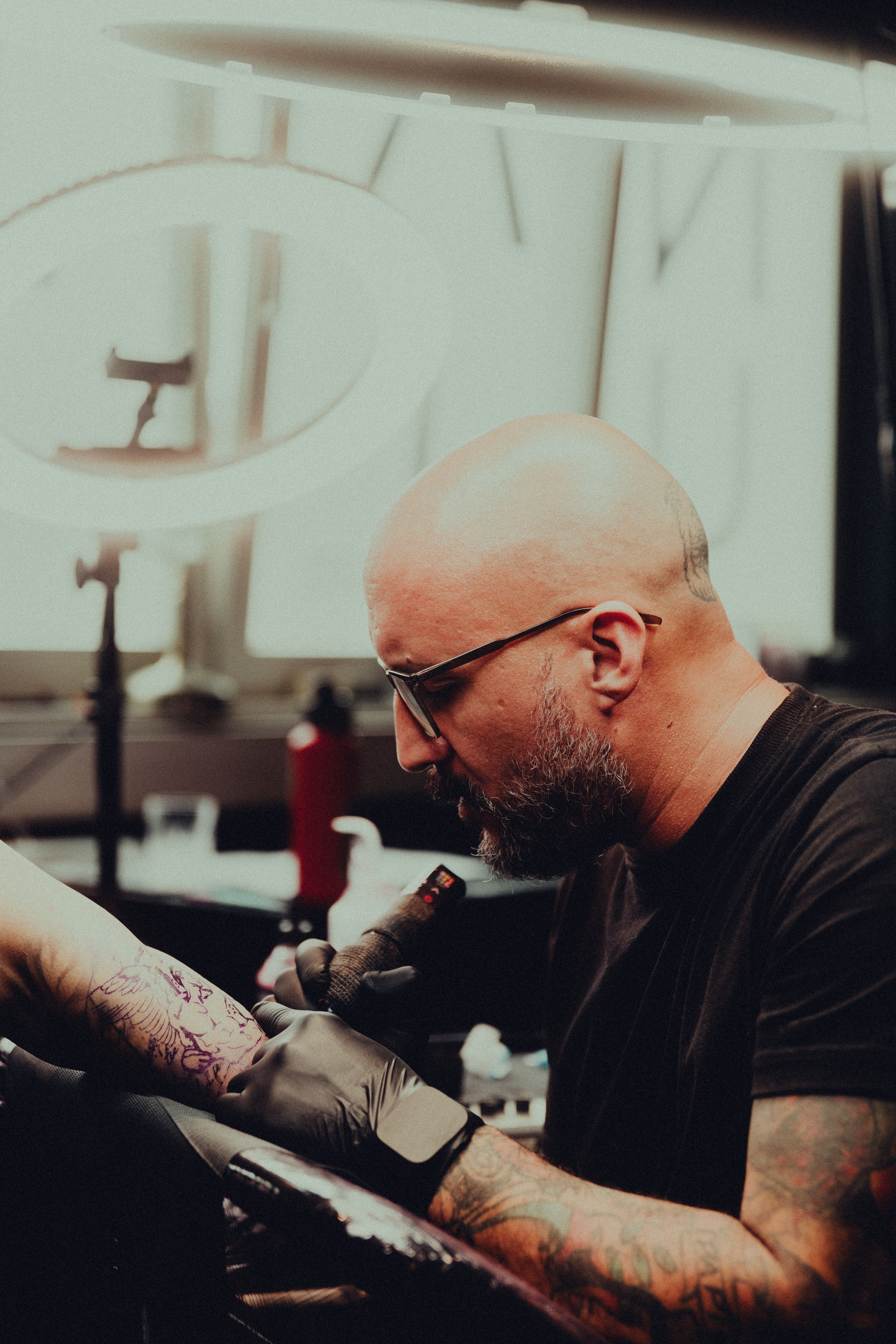 Professional Tattoo Artist Creating Intricate Design · Free Stock Photo