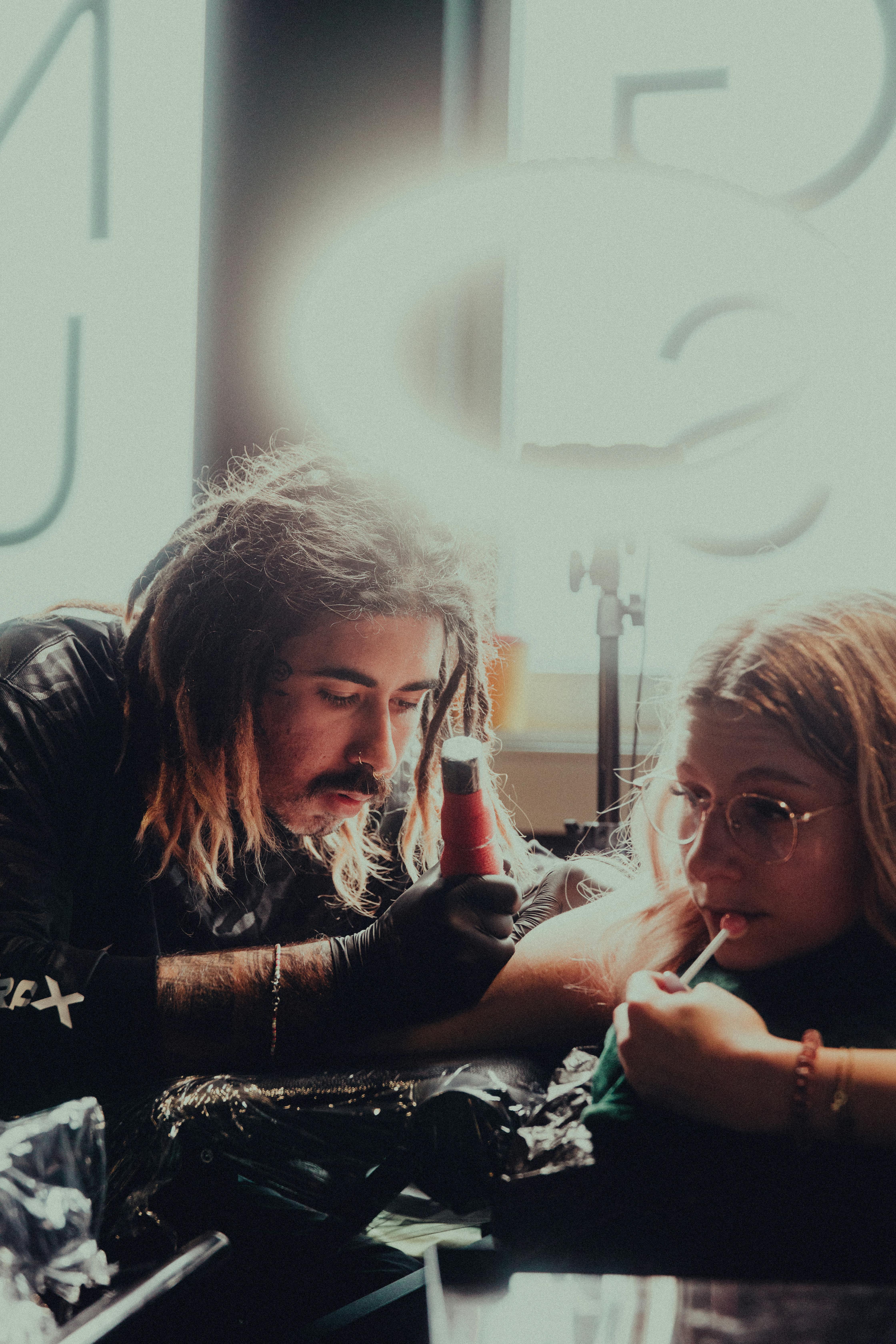 Artistic Tattoo Session in a Modern Studio · Free Stock Photo