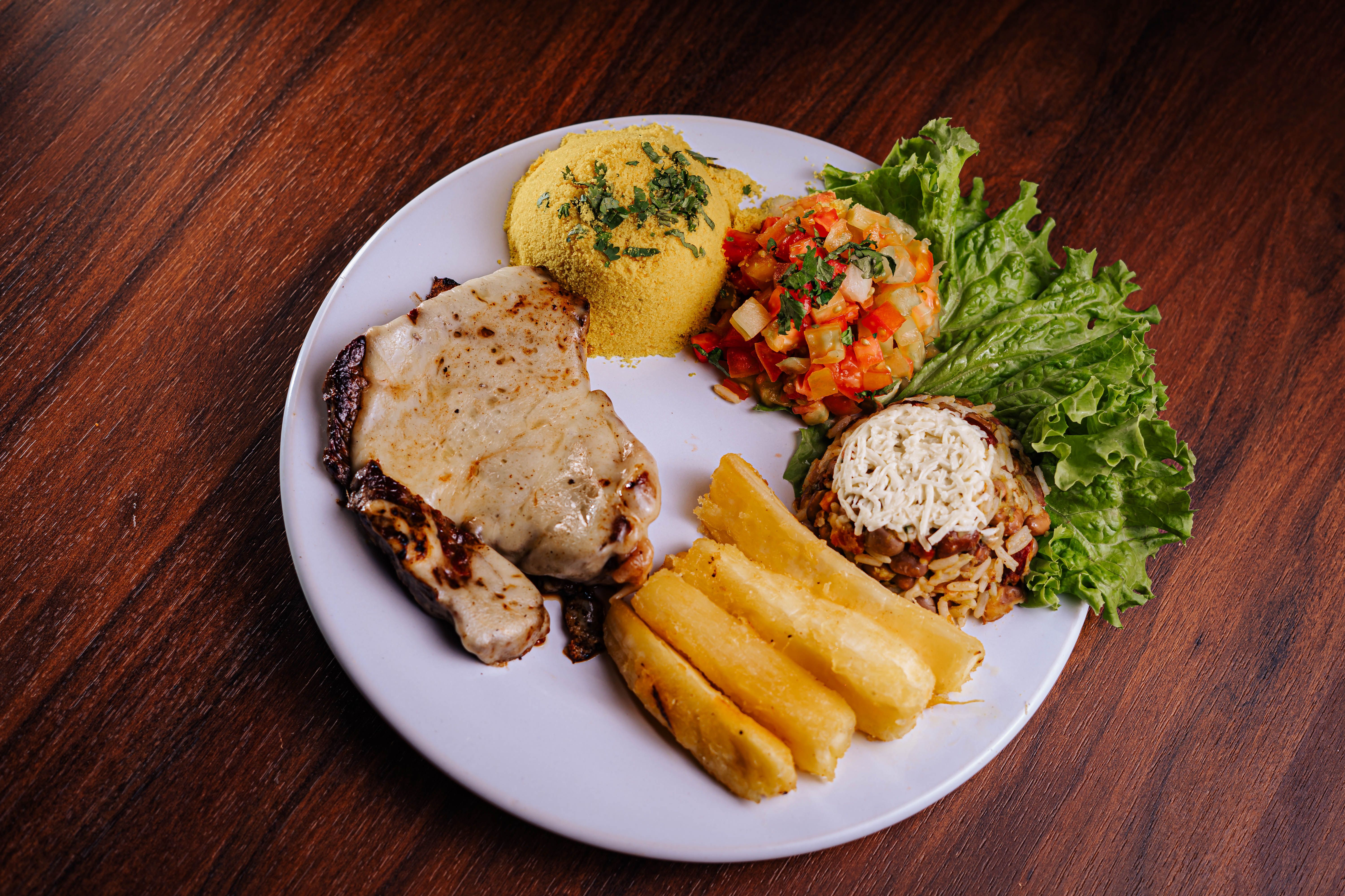 Varied Brazilian Cuisine on Wooden Table · Free Stock Photo