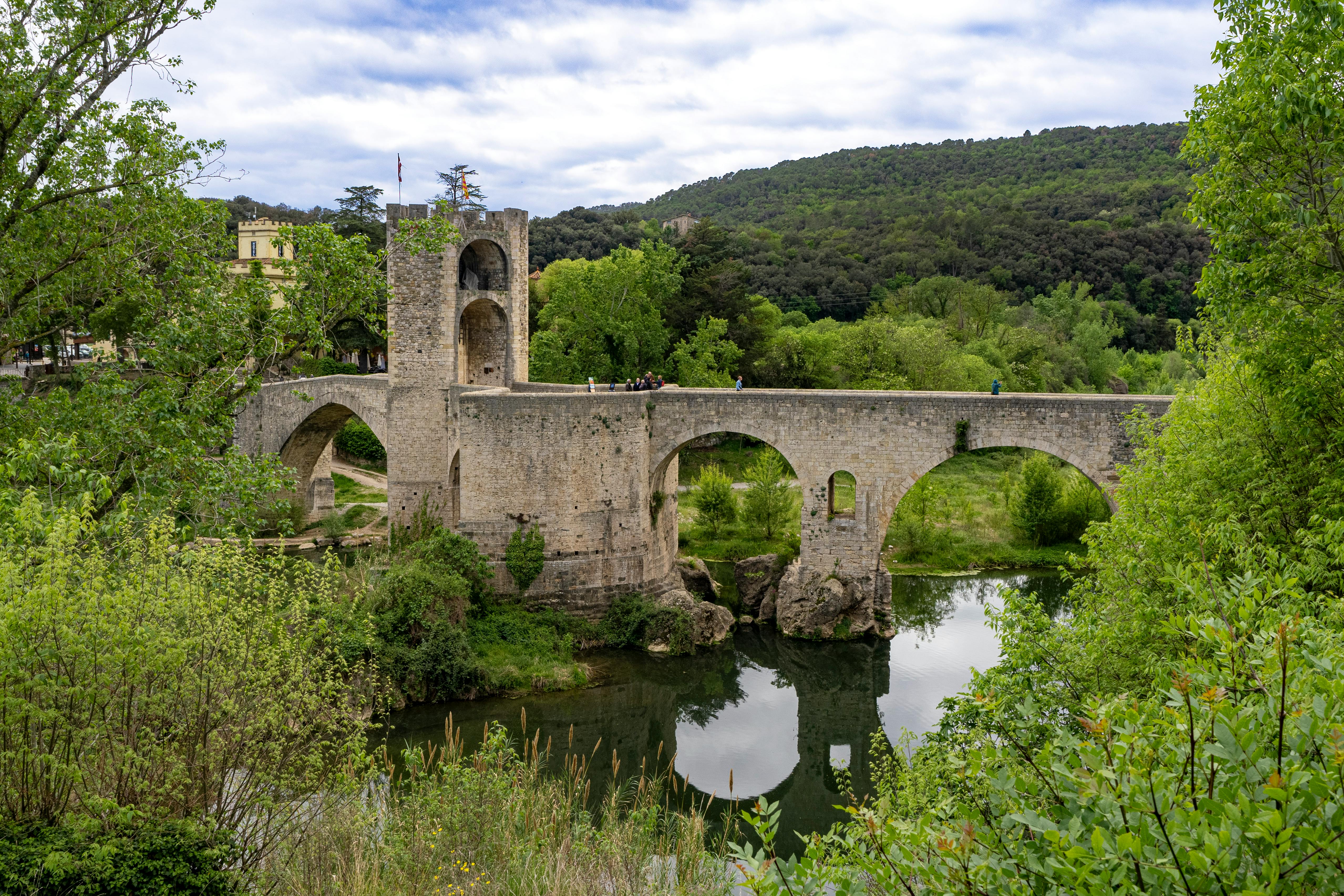 Medieval Stone Bridge Over Tranquil River · Free Stock Photo