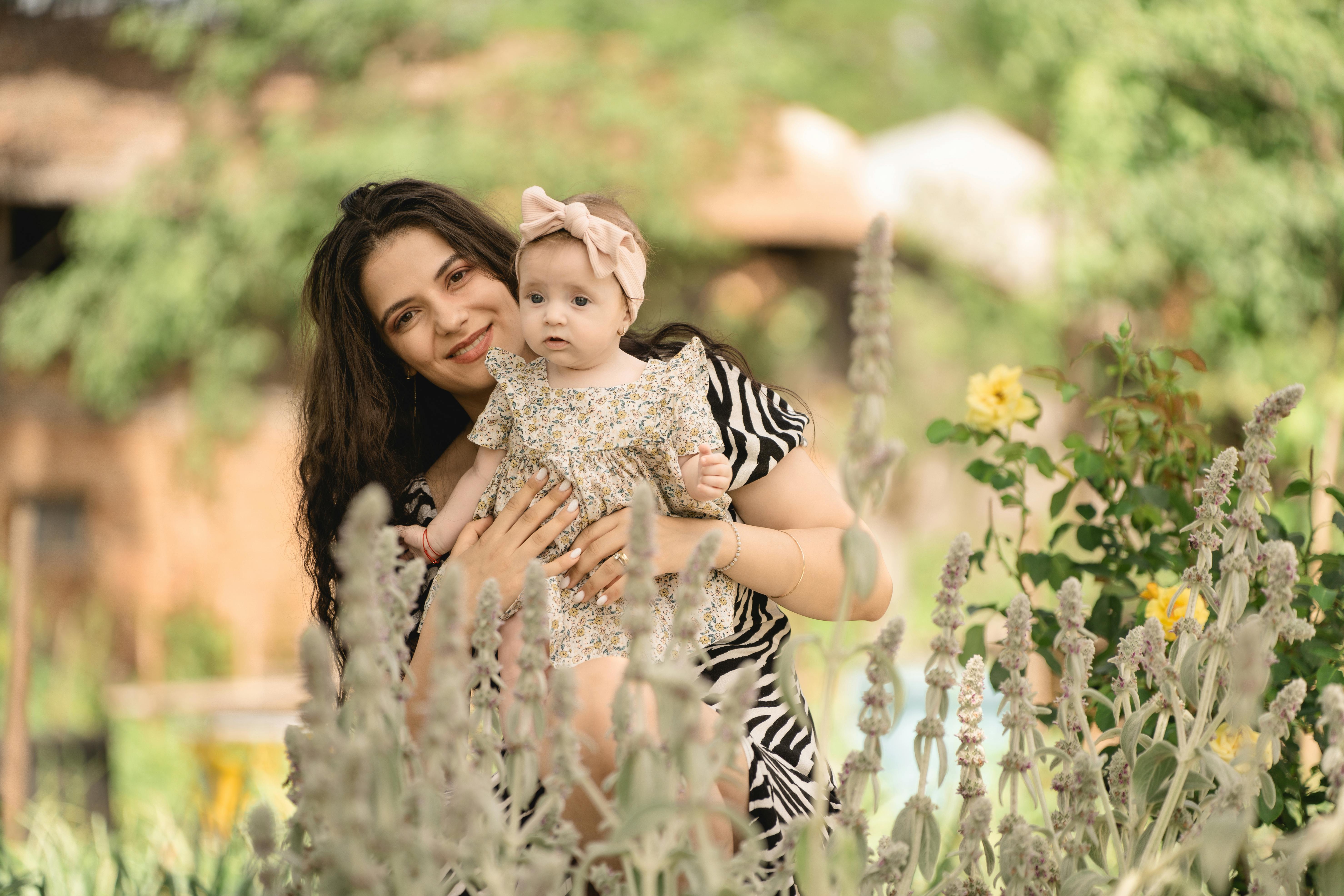Mother and Baby Bonding in a Lush Garden · Free Stock Photo