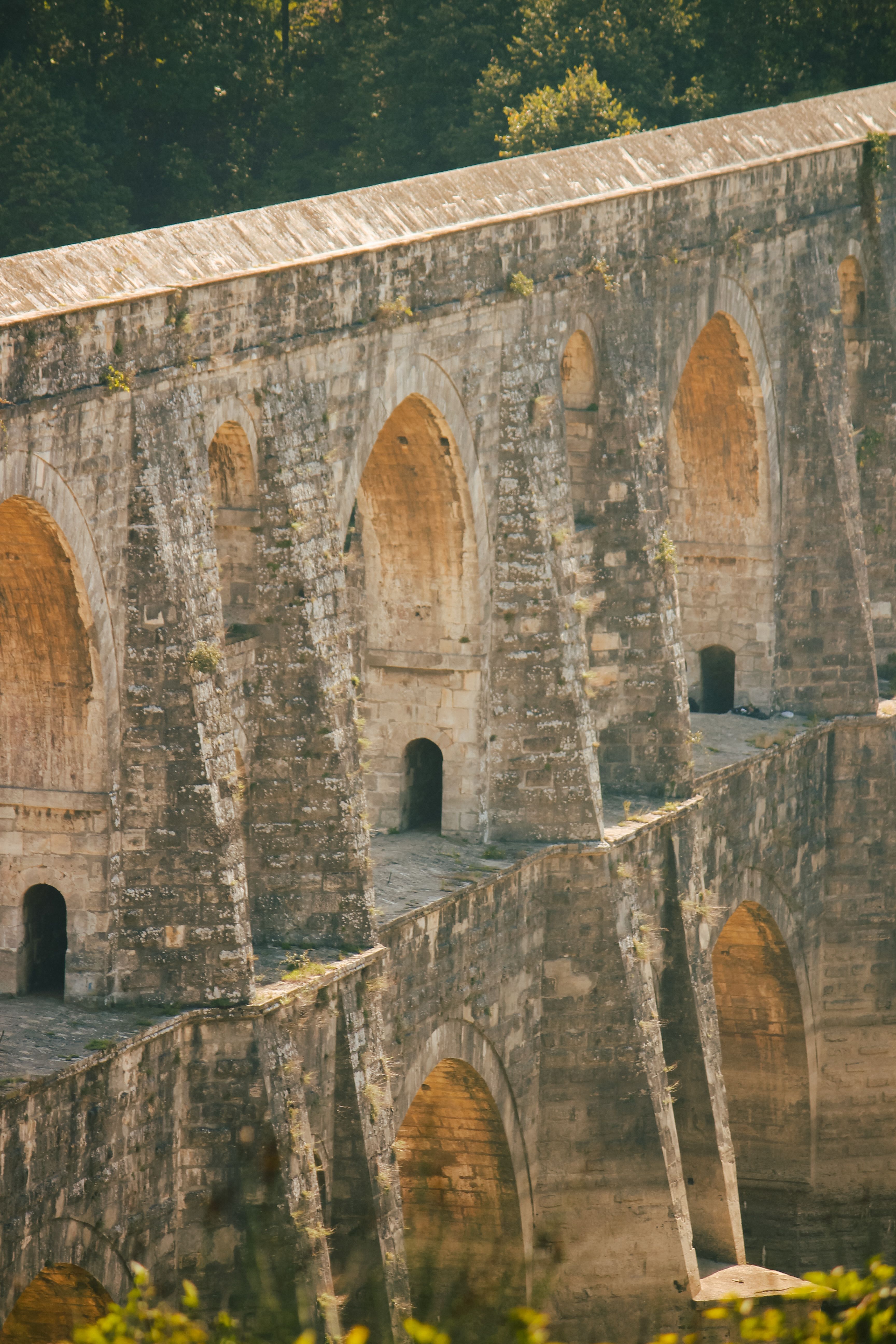 Ancient Stone Aqueduct Detail in Sunlight · Free Stock Photo