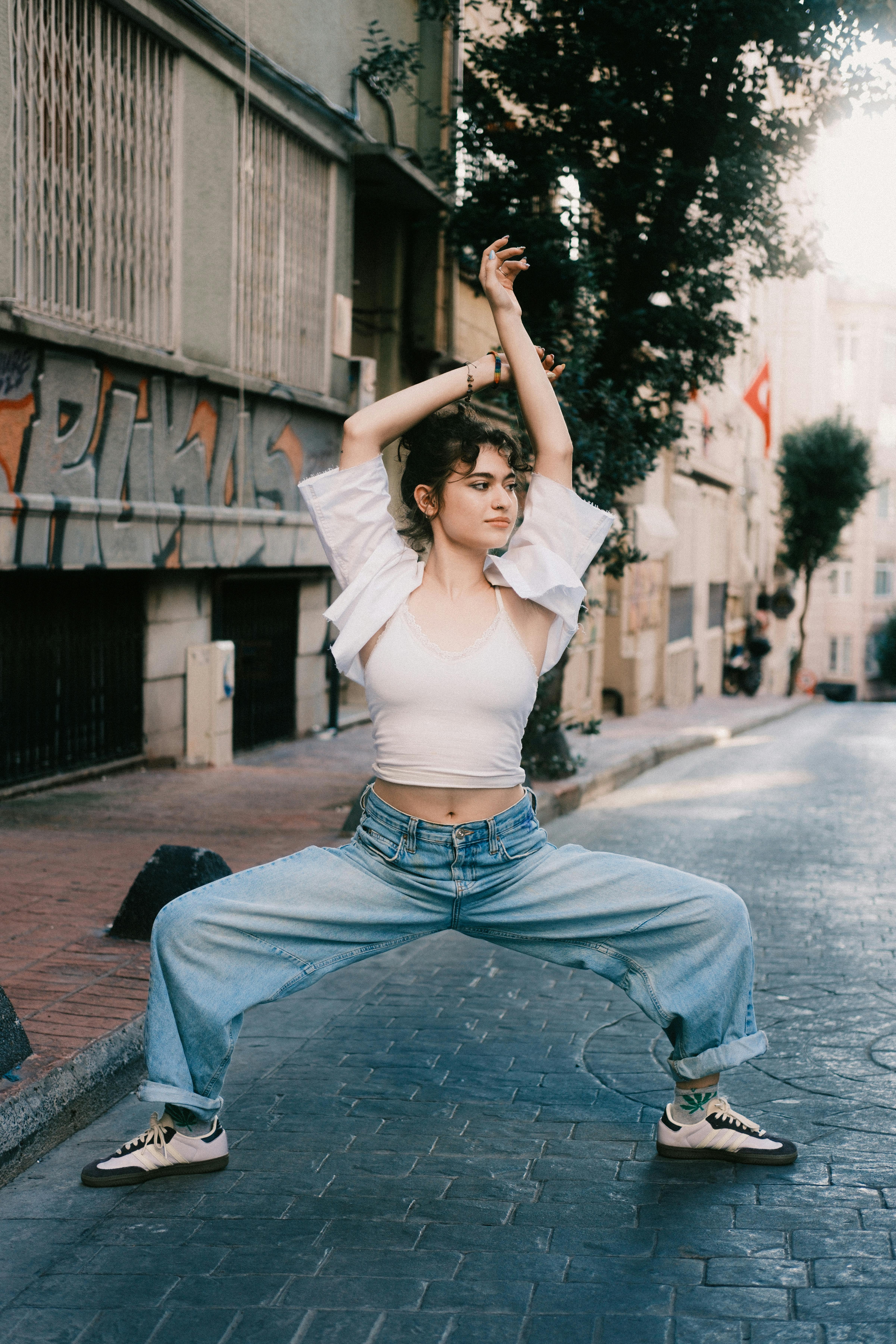 Young Woman Street Dance Pose in Urban Setting · Free Stock Photo