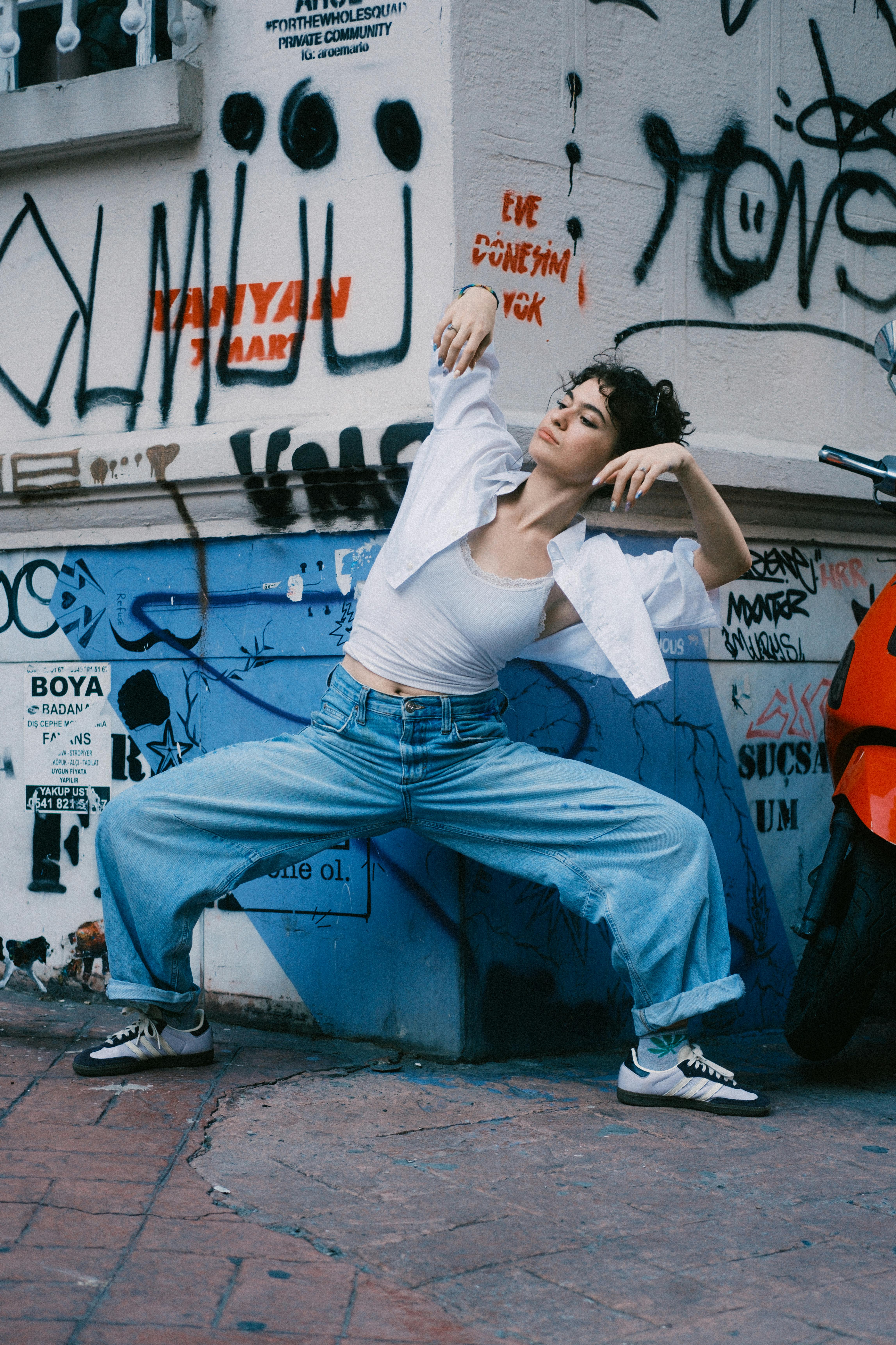Urban Dance Pose Against Graffiti Wall · Free Stock Photo