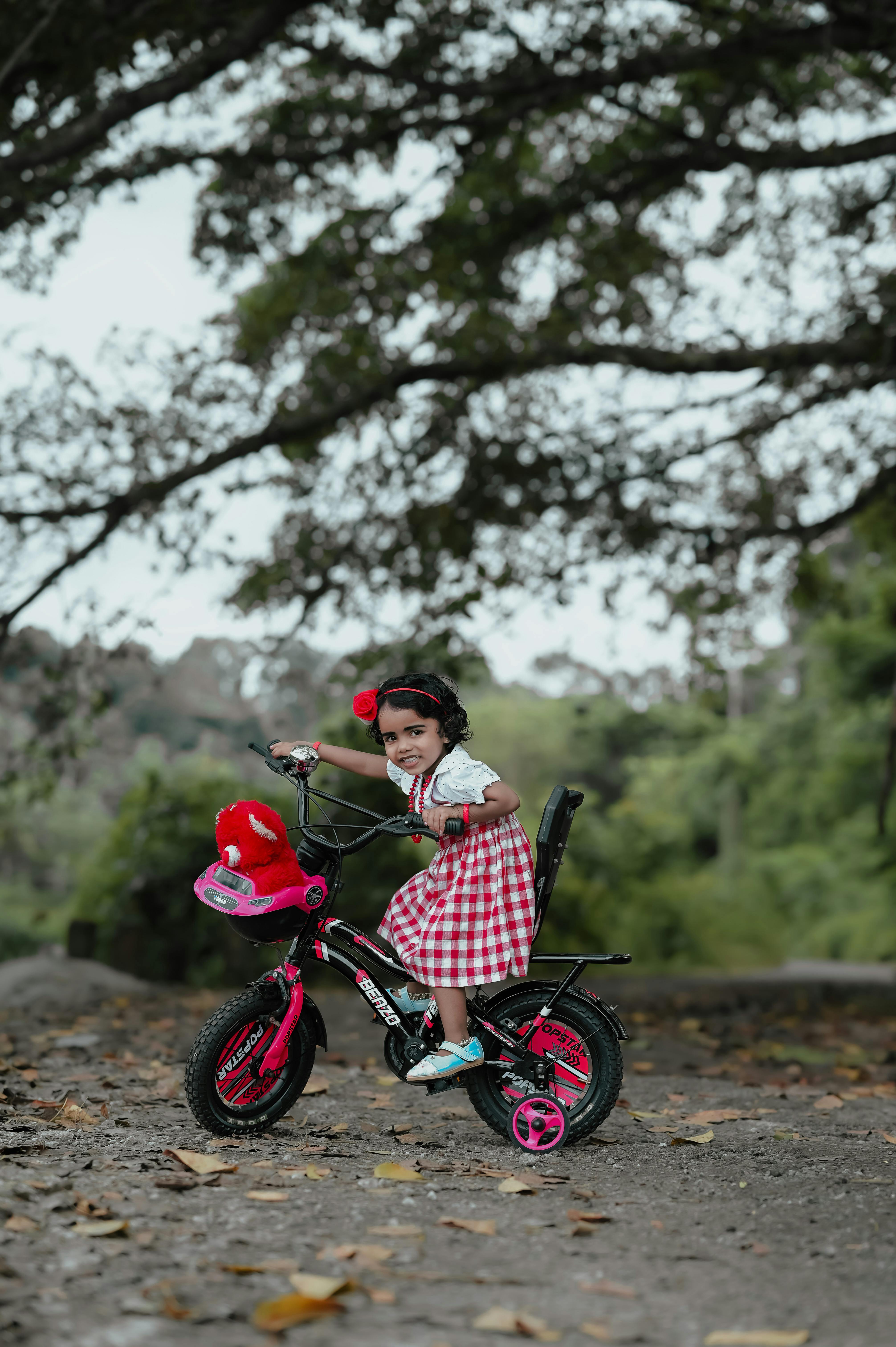 Child Riding Bicycle in Scenic Park Setting · Free Stock Photo