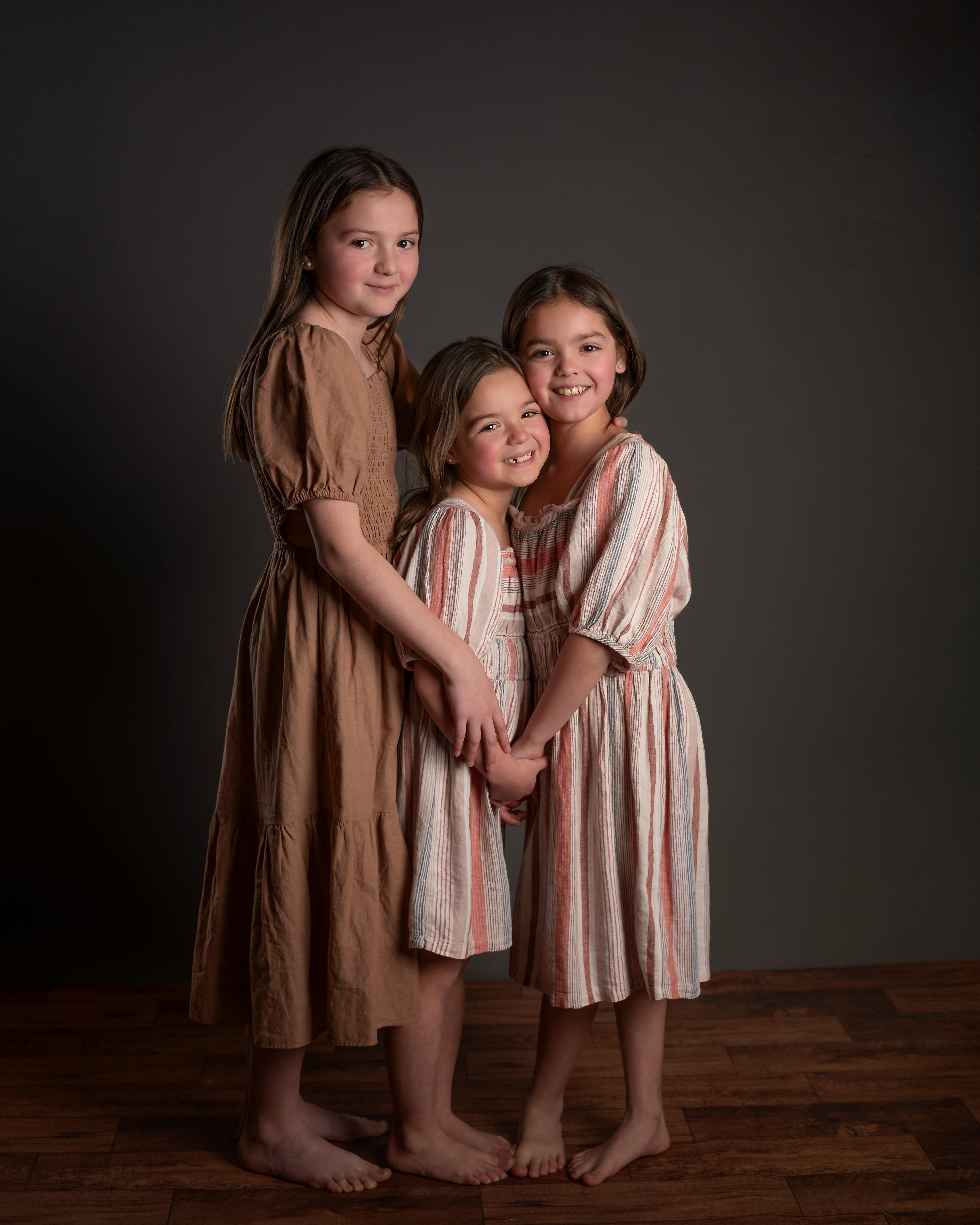 Heartwarming Portrait of Three Sisters in Studio · Free Stock Photo
