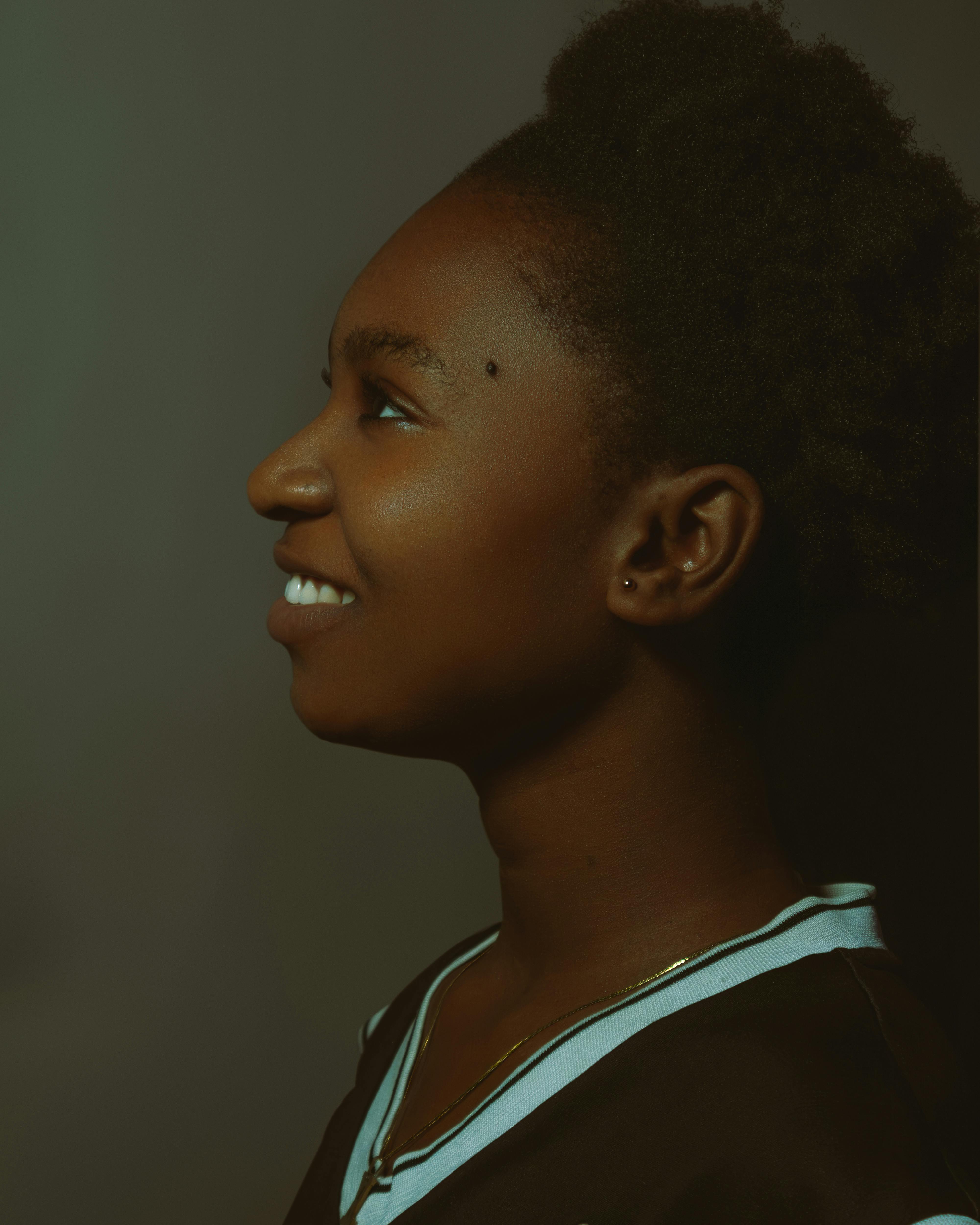 Portrait of Smiling Woman in Profile View · Free Stock Photo