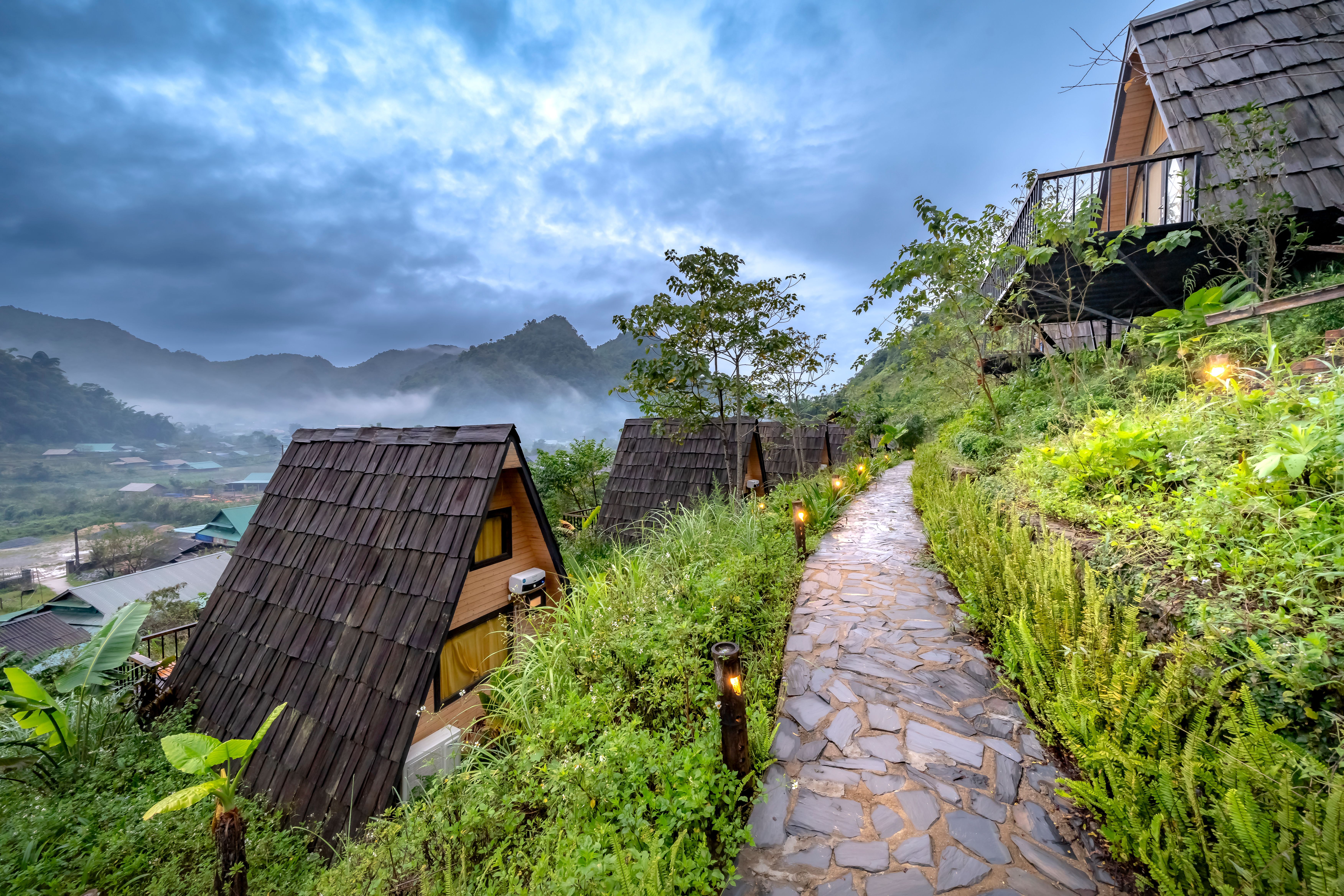 Charming Mountain Cabins in Lush Green Landscape · Free Stock Photo