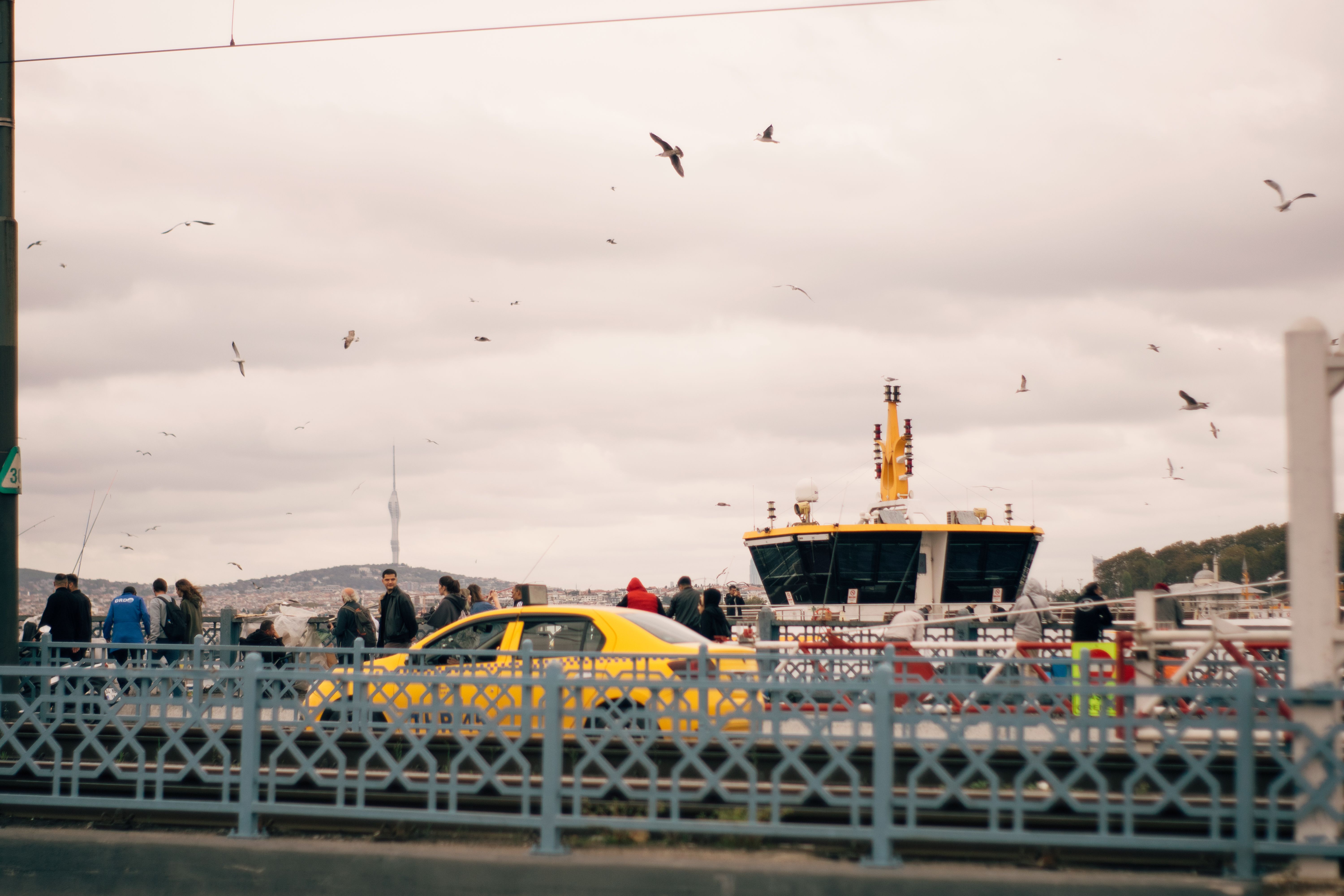 Busy Urban Scene with Ferry and Yellow Taxi · Free Stock Photo