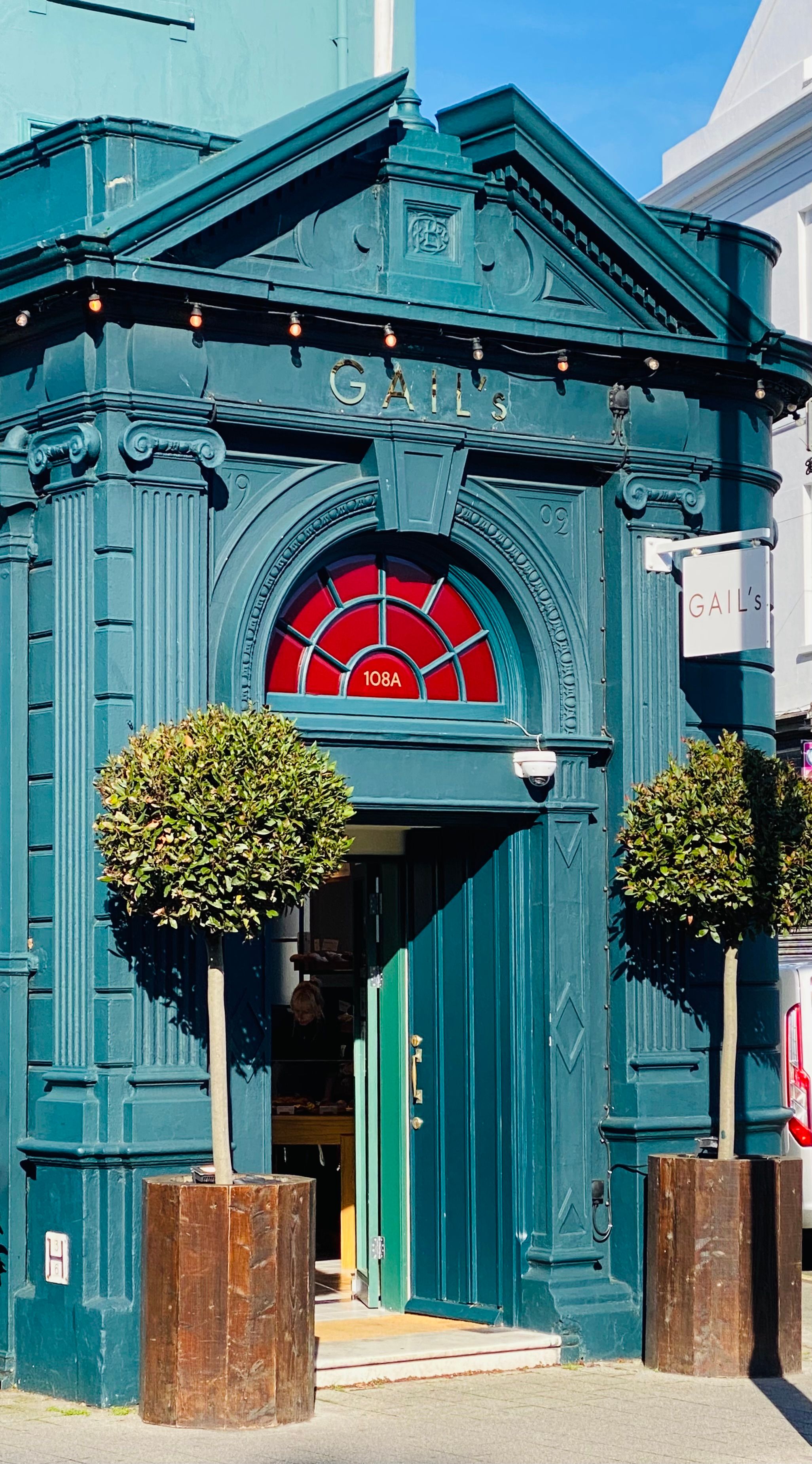 Charming Urban Bakery Entrance with Elegant Doorway · Free Stock Photo