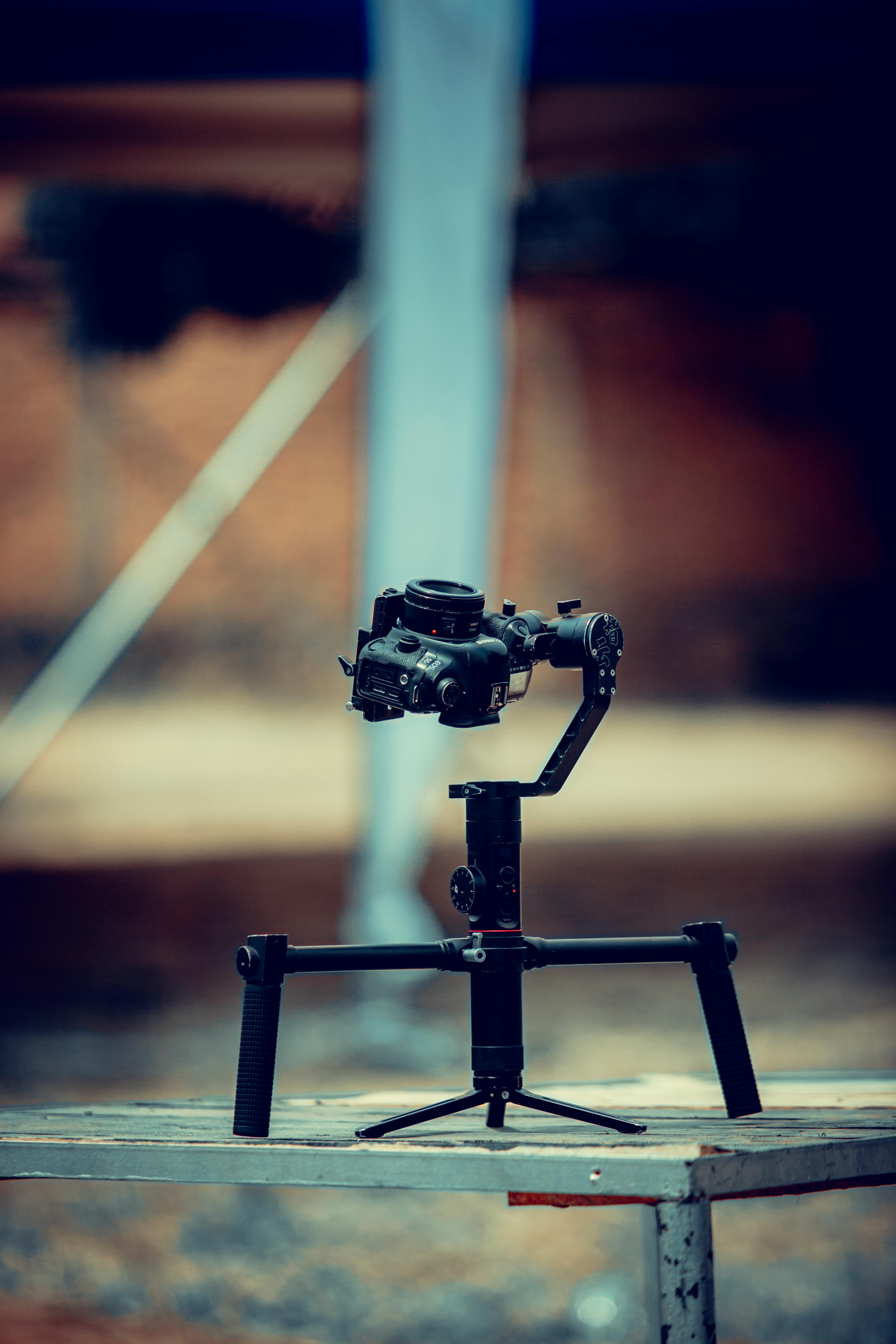 Professional Camera Stabilizer on Outdoor Table · Free Stock Photo