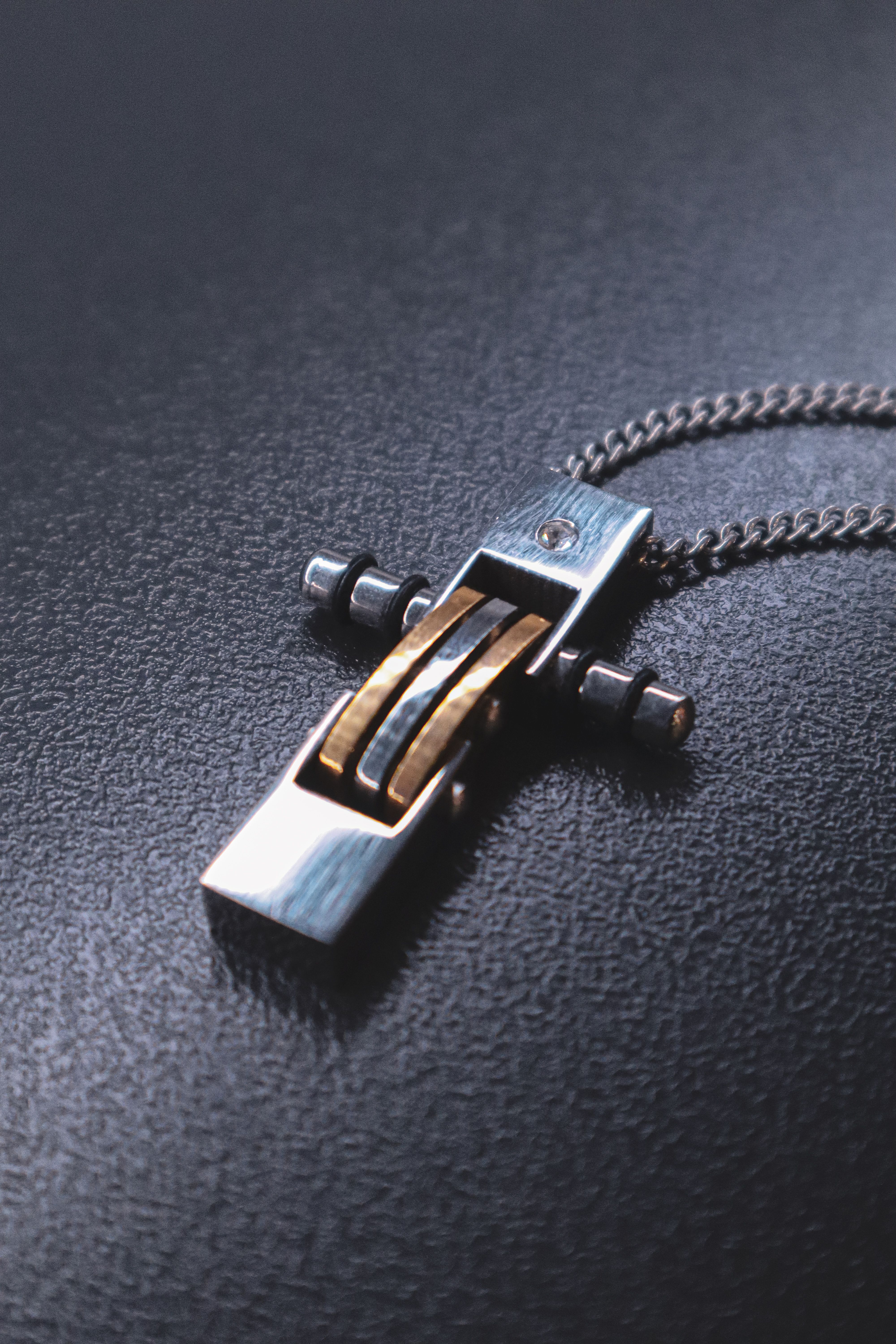 Close-up of Modern Metallic Cross Pendant · Free Stock Photo