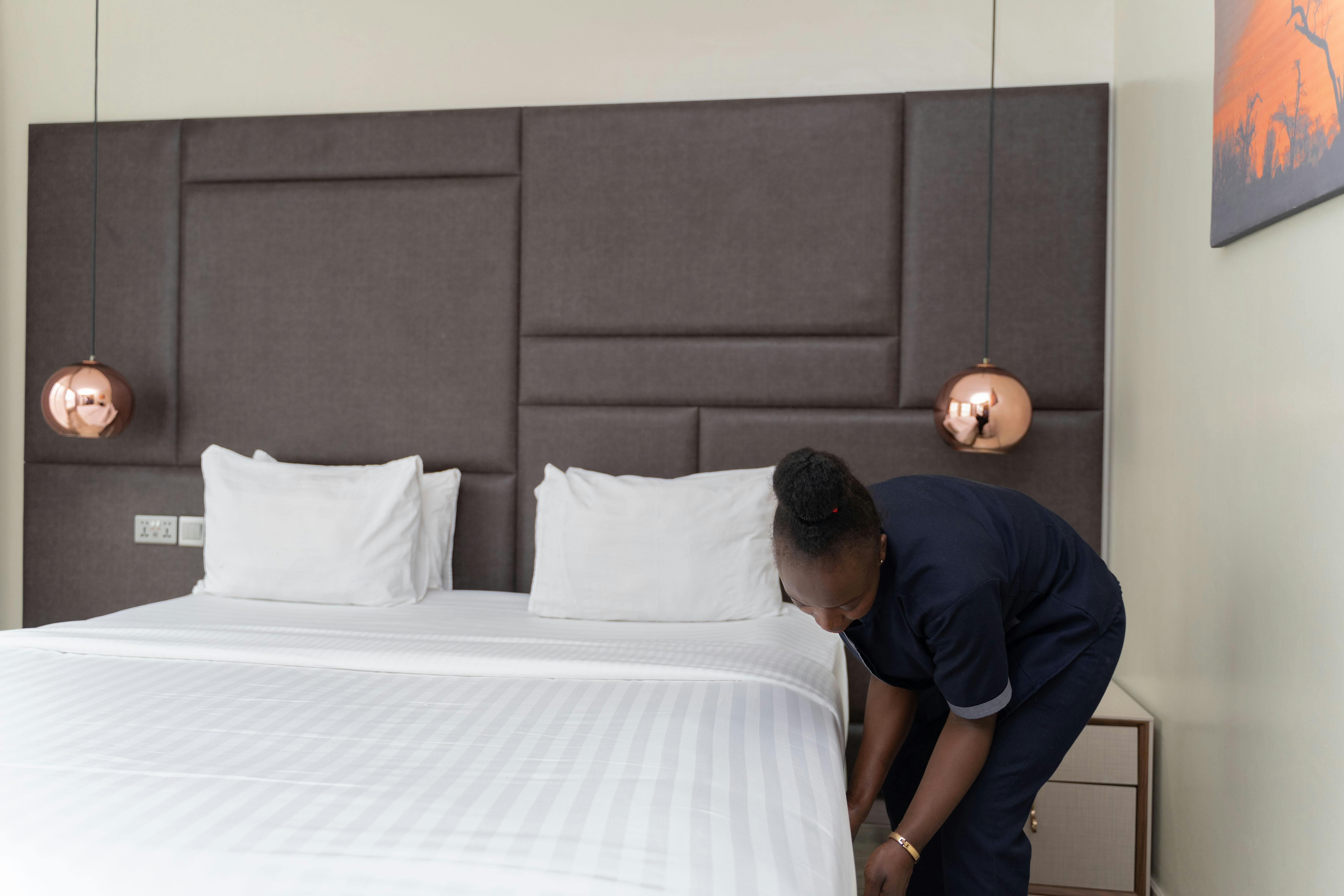 Hotel Staff Making Bed in Modern Room · Free Stock Photo