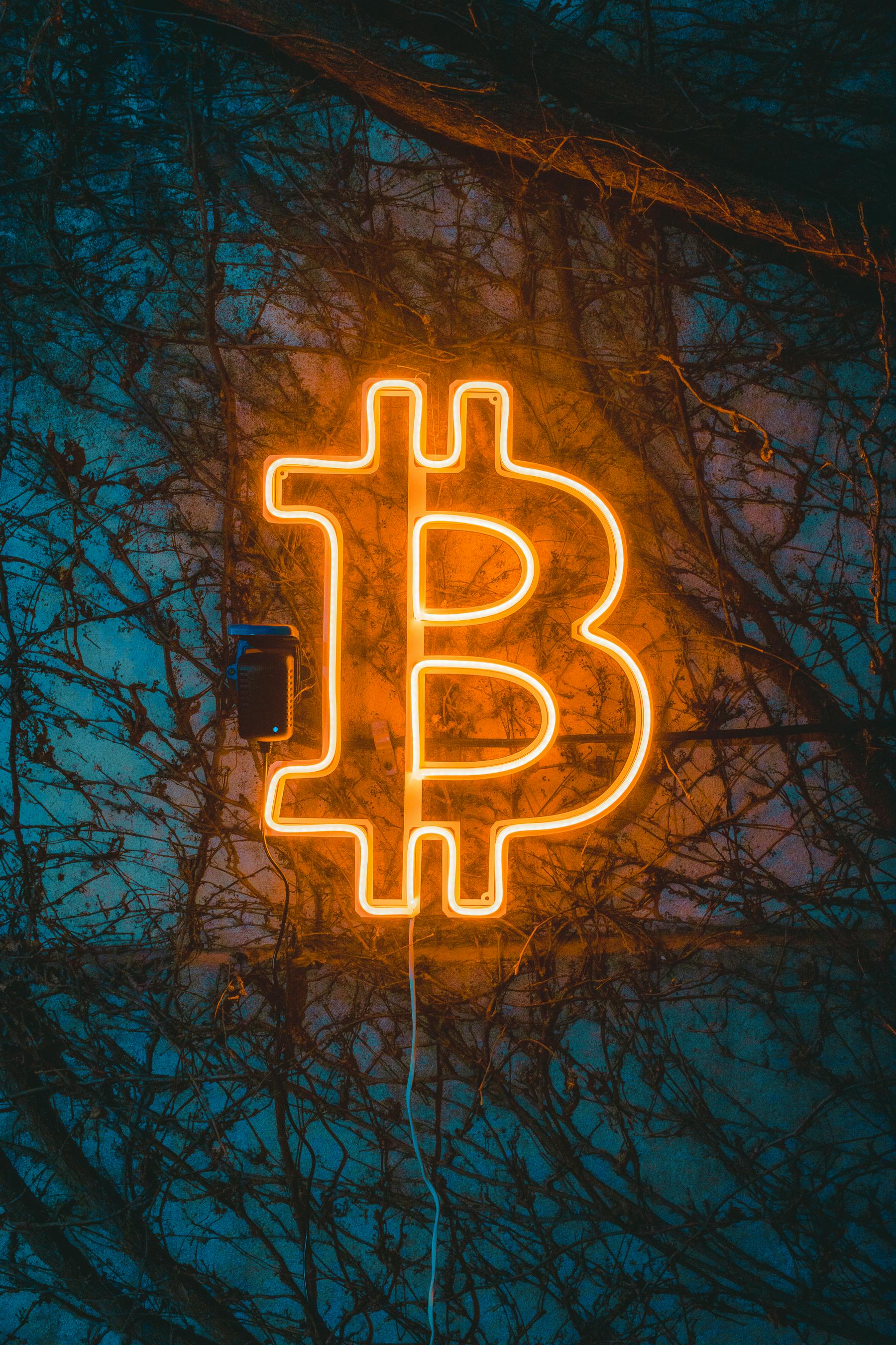 Vibrant Bitcoin Neon Sign on Textured Wall · Free Stock Photo