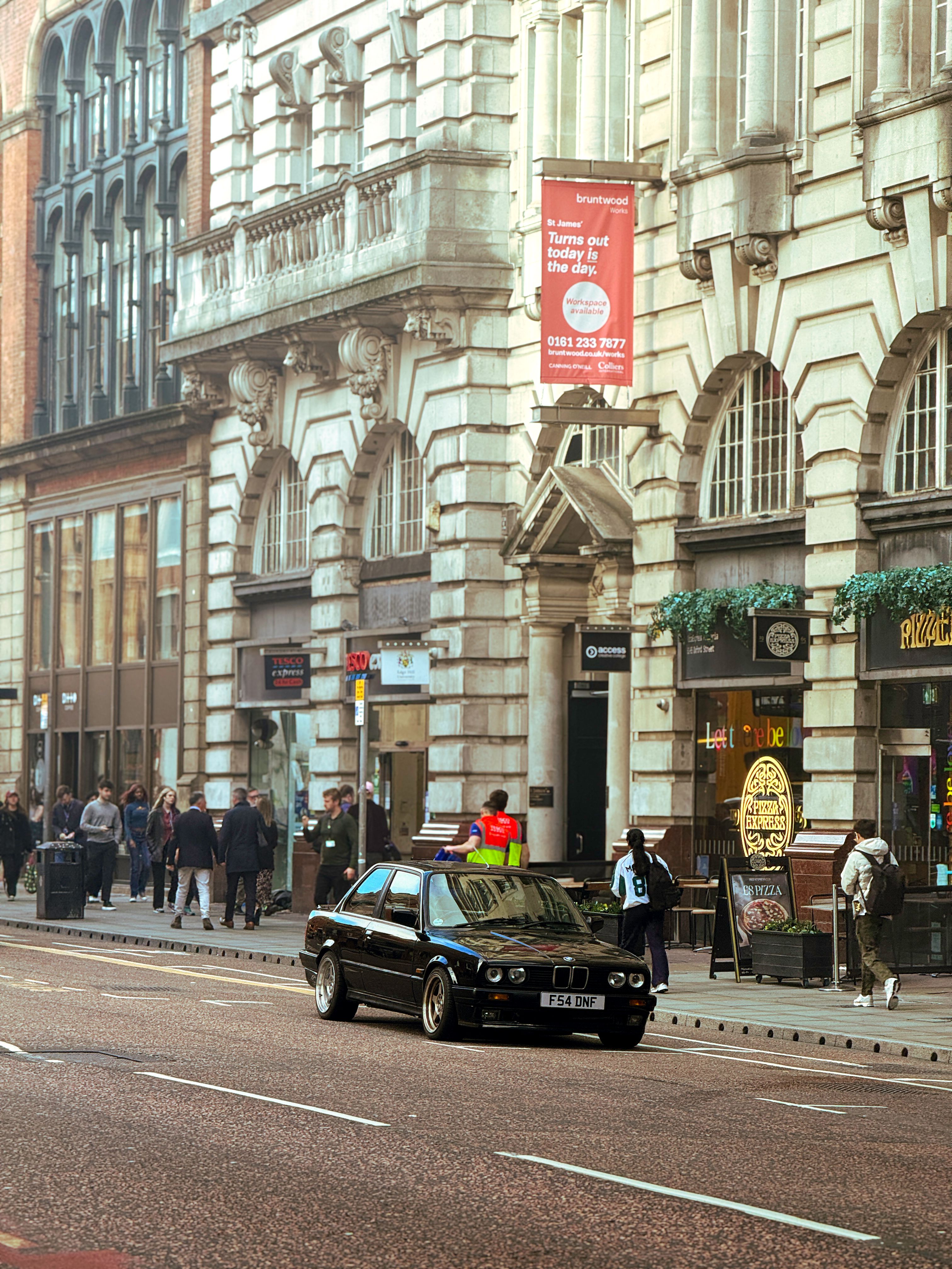 Historic Street Scene with Classic Car and Foot Traffic · Free Stock Photo