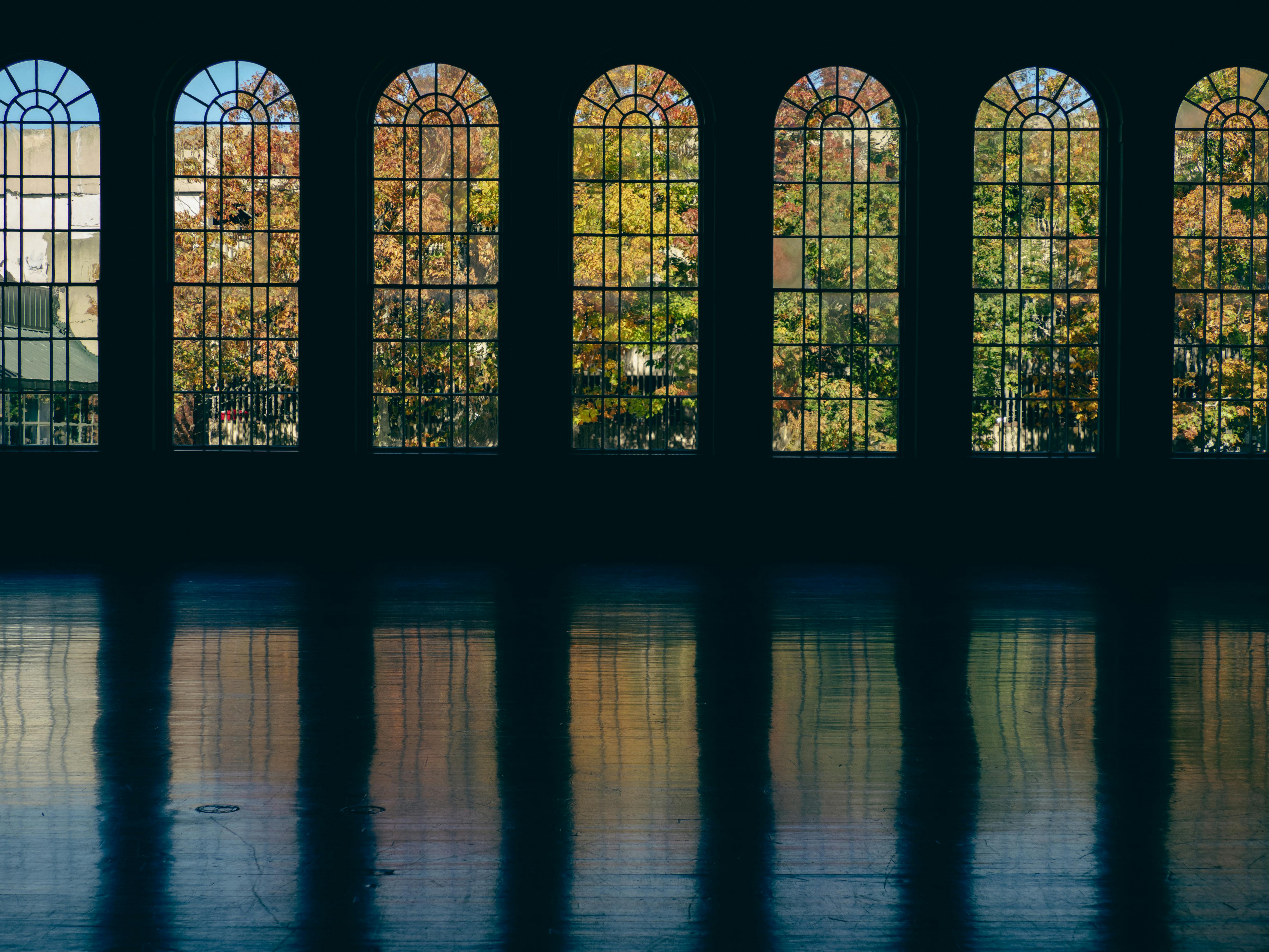 Elegant Arched Windows Overlooking Autumn Foliage · Free Stock Photo