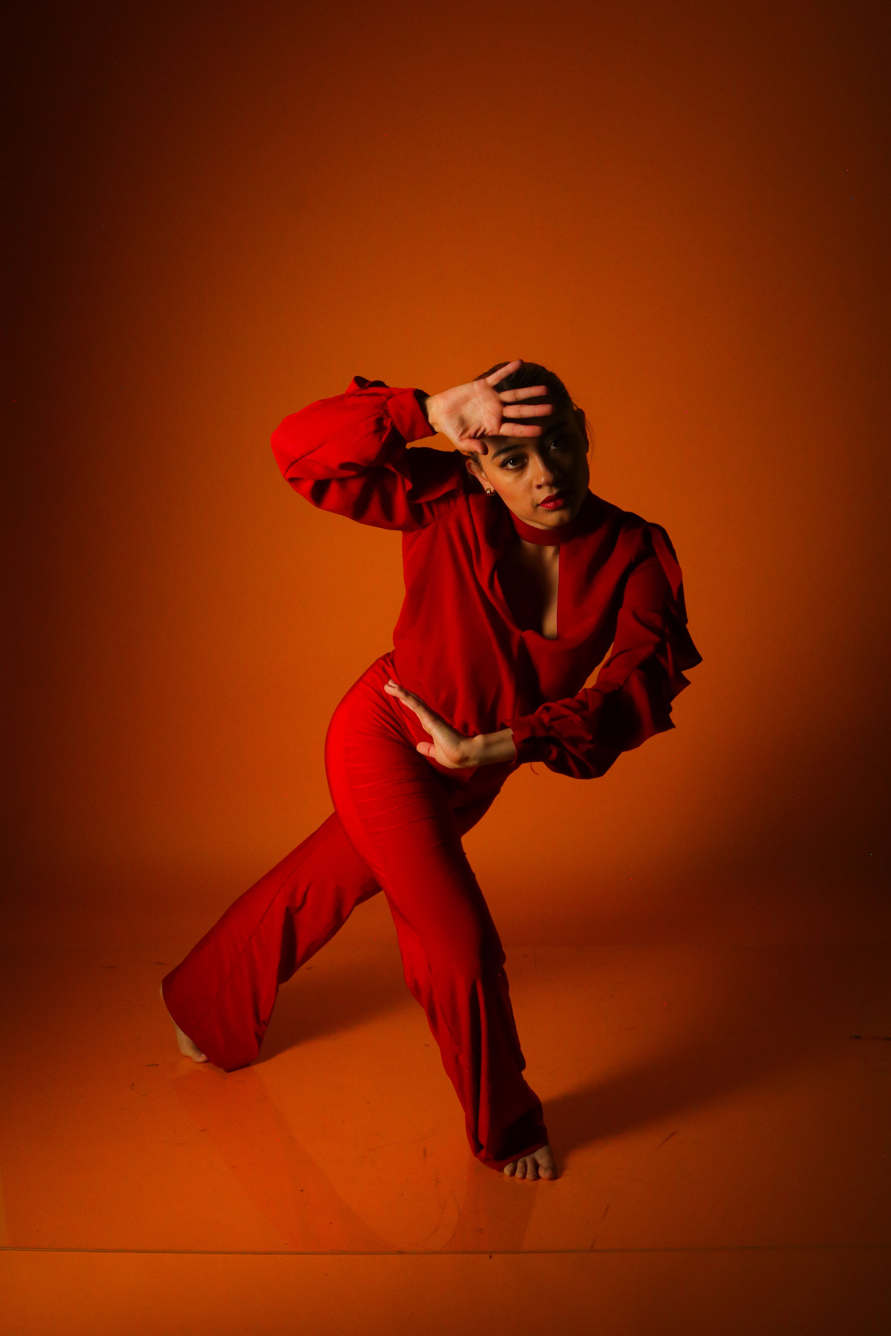 Expressive Dance Pose in Vibrant Red Attire · Free Stock Photo