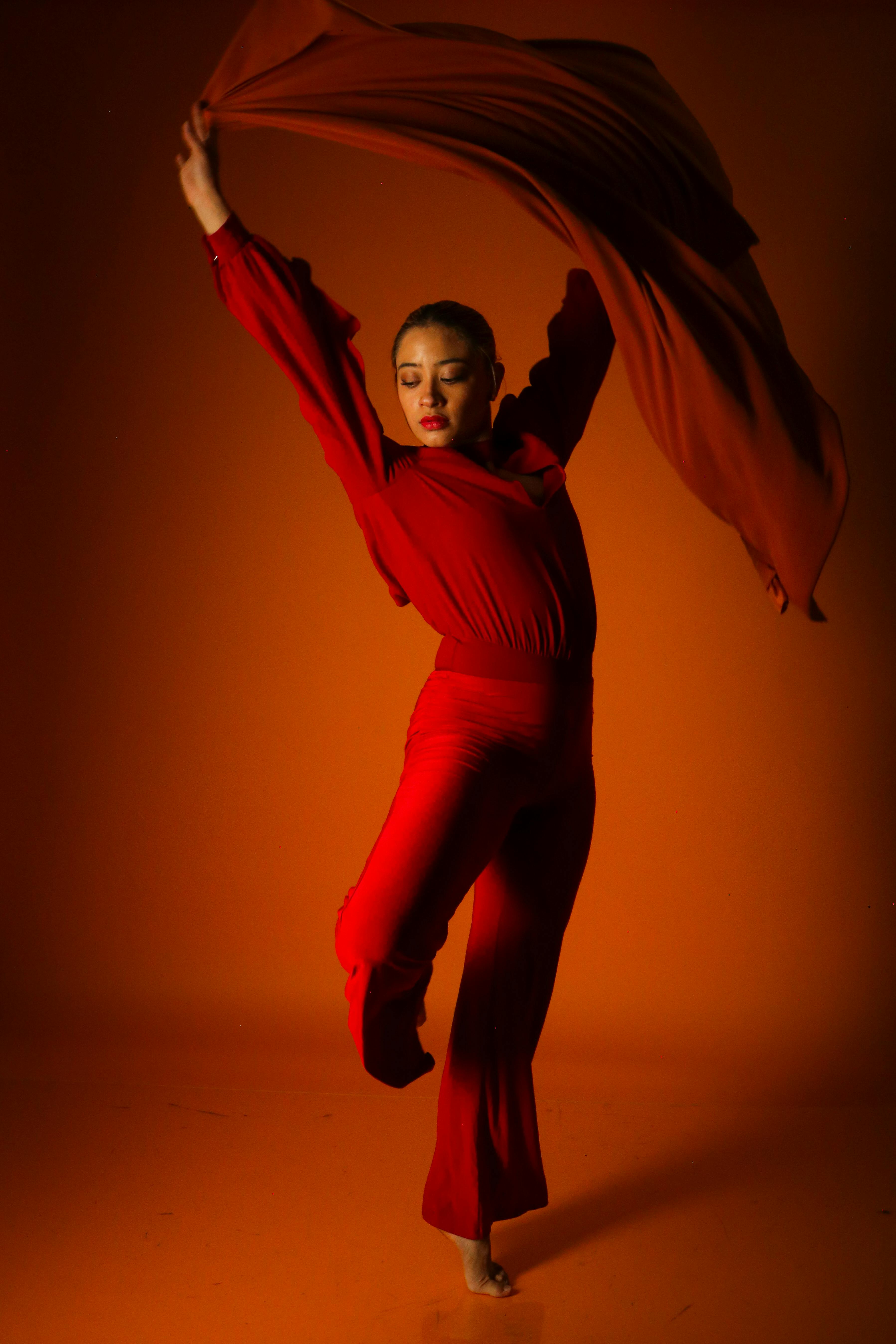 Dynamic Dancer in Fiery Red Pose · Free Stock Photo