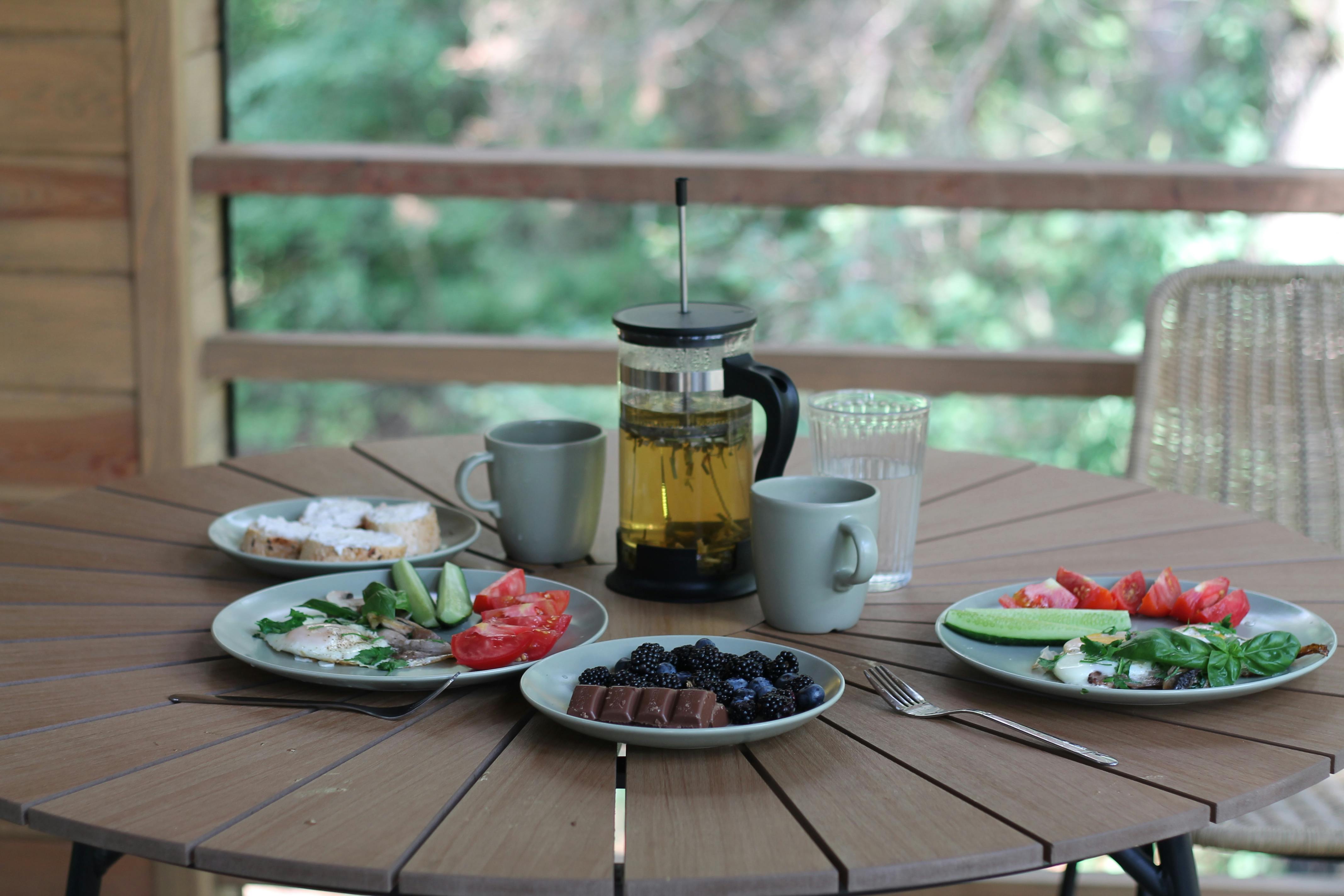 Cozy Outdoor Breakfast Setting on Wooden Porch · Free Stock Photo