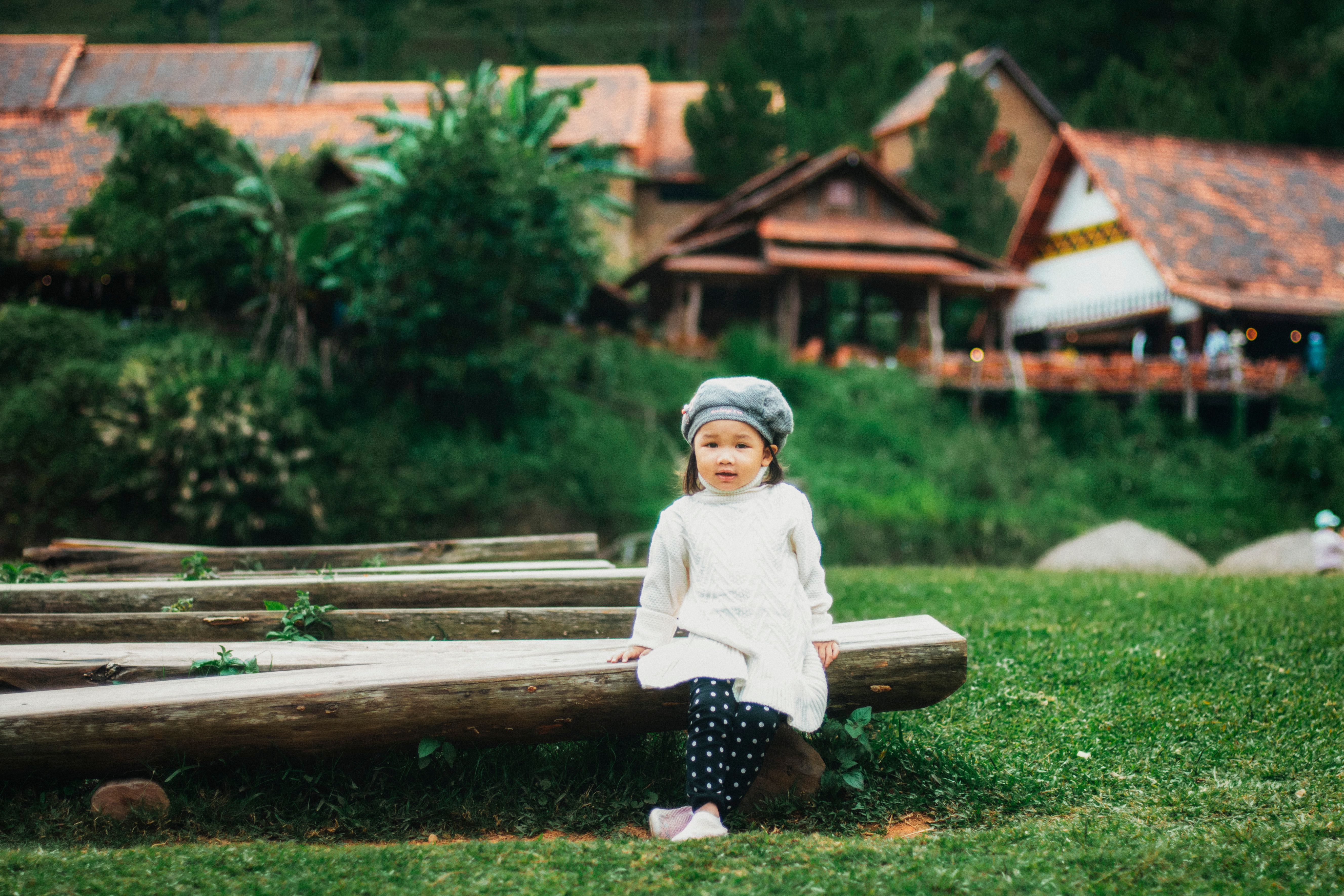 Girl Sitting on Log · Free Stock Photo