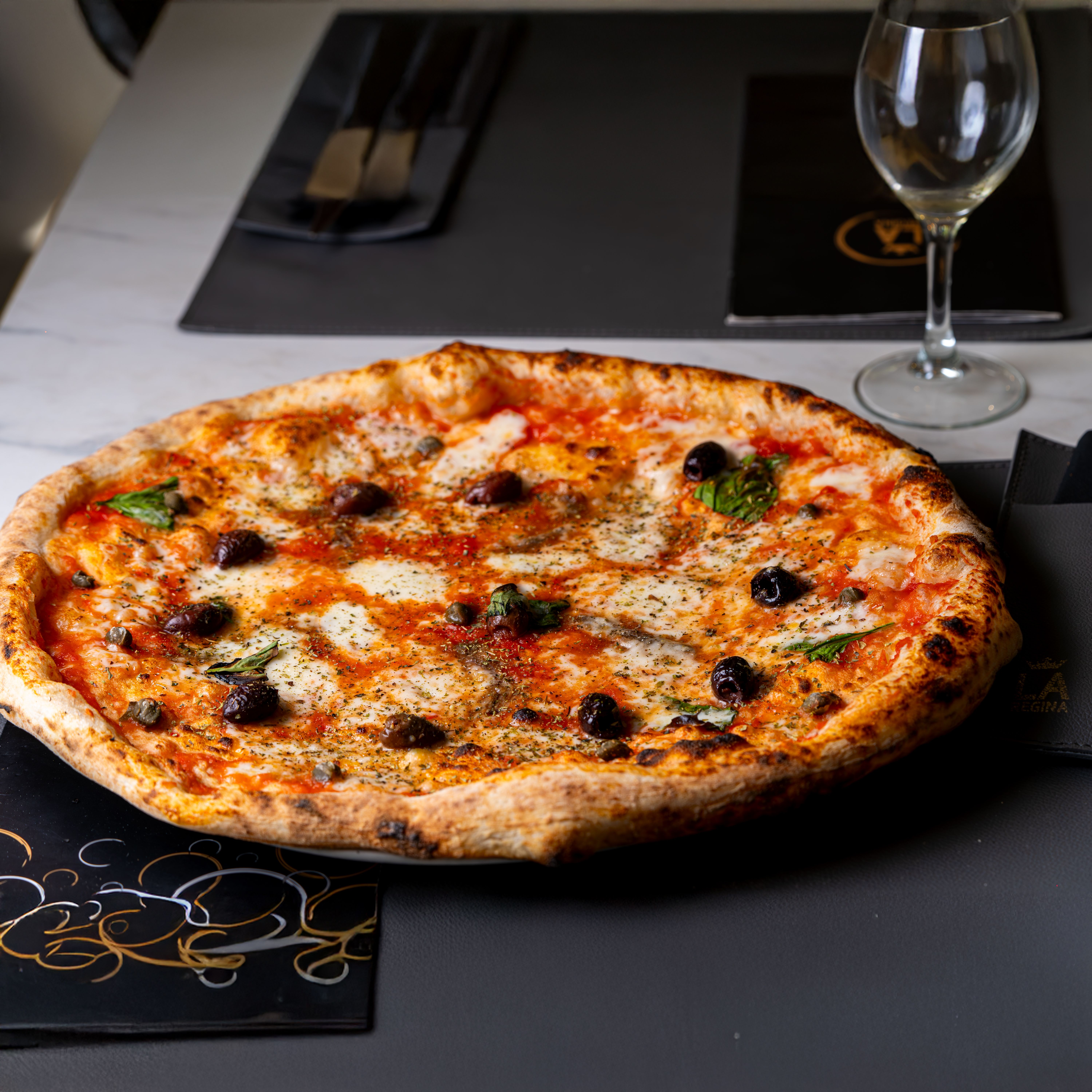 Delicious Margherita Pizza on a Restaurant Table · Free Stock Photo
