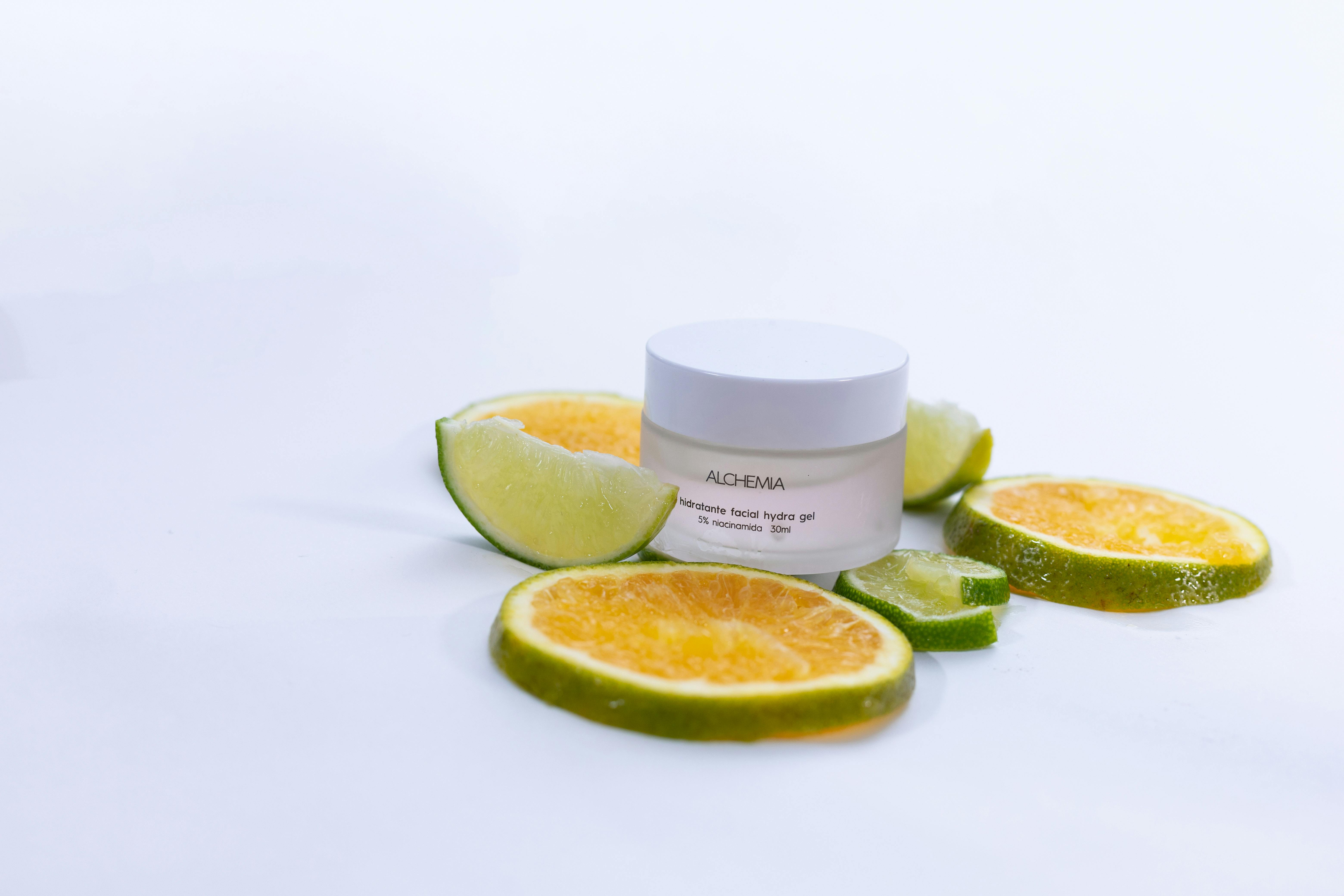 Citrus-infused skincare product with fresh fruit · Free Stock Photo