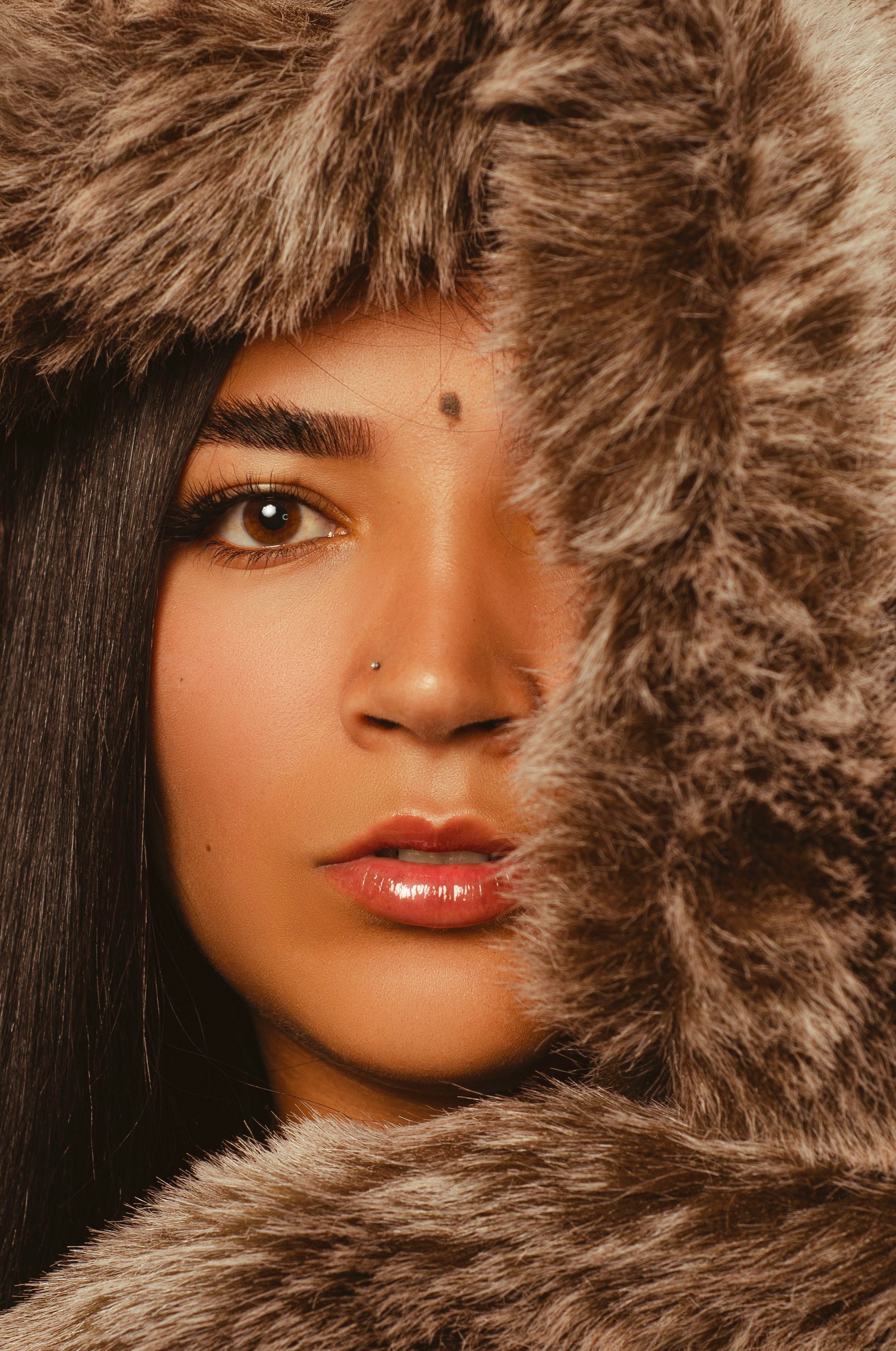 Portrait of Woman in Fur Hood with Bold Expression · Free Stock Photo