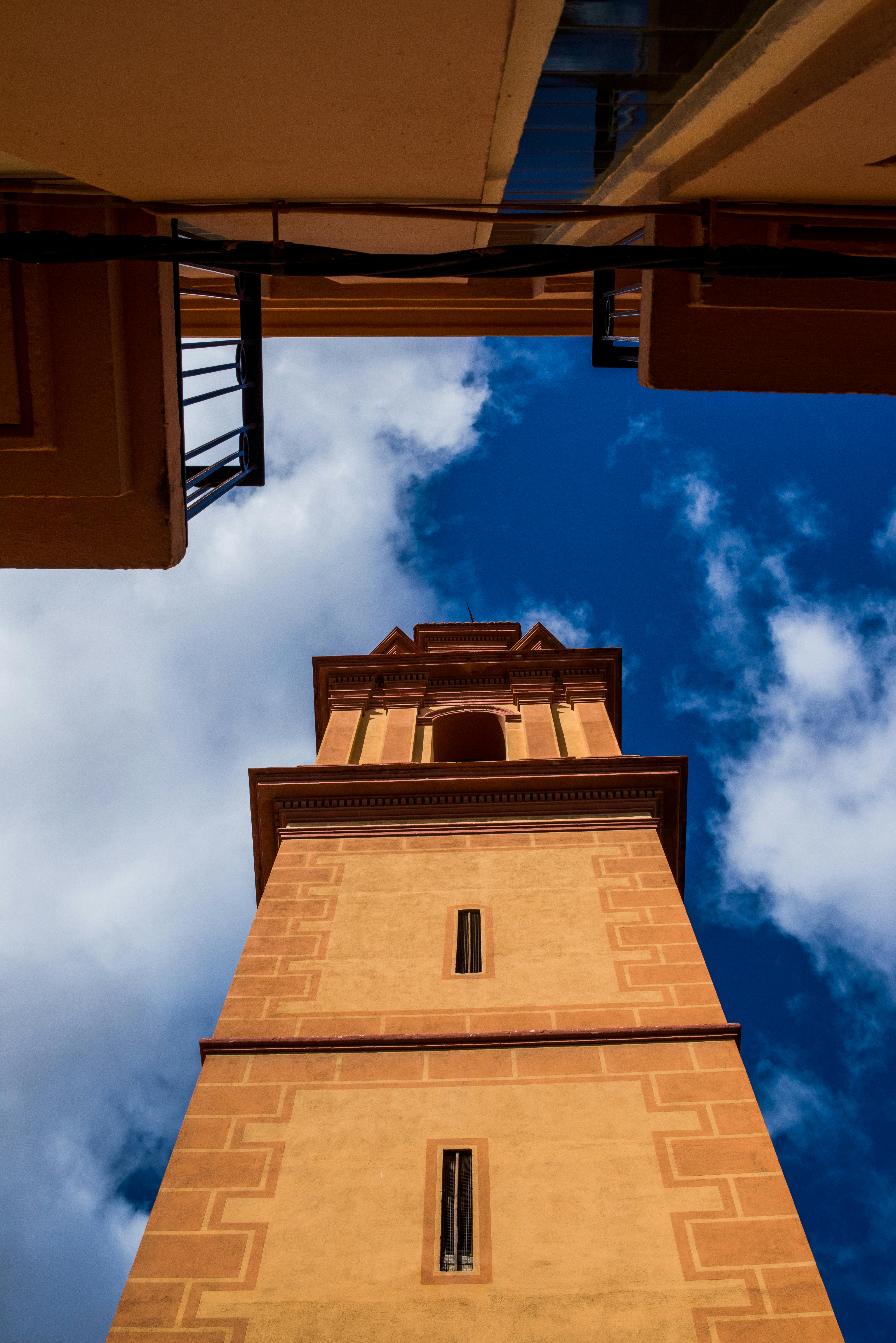 Upward View of Historic Bell Tower Against Blue Sky · Free Stock Photo