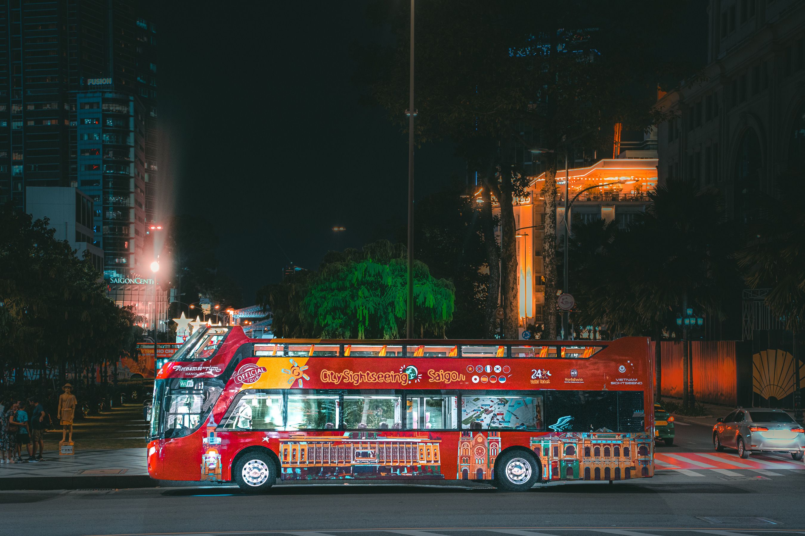 Colorful Night City Tour Bus in Urban Setting · Free Stock Photo