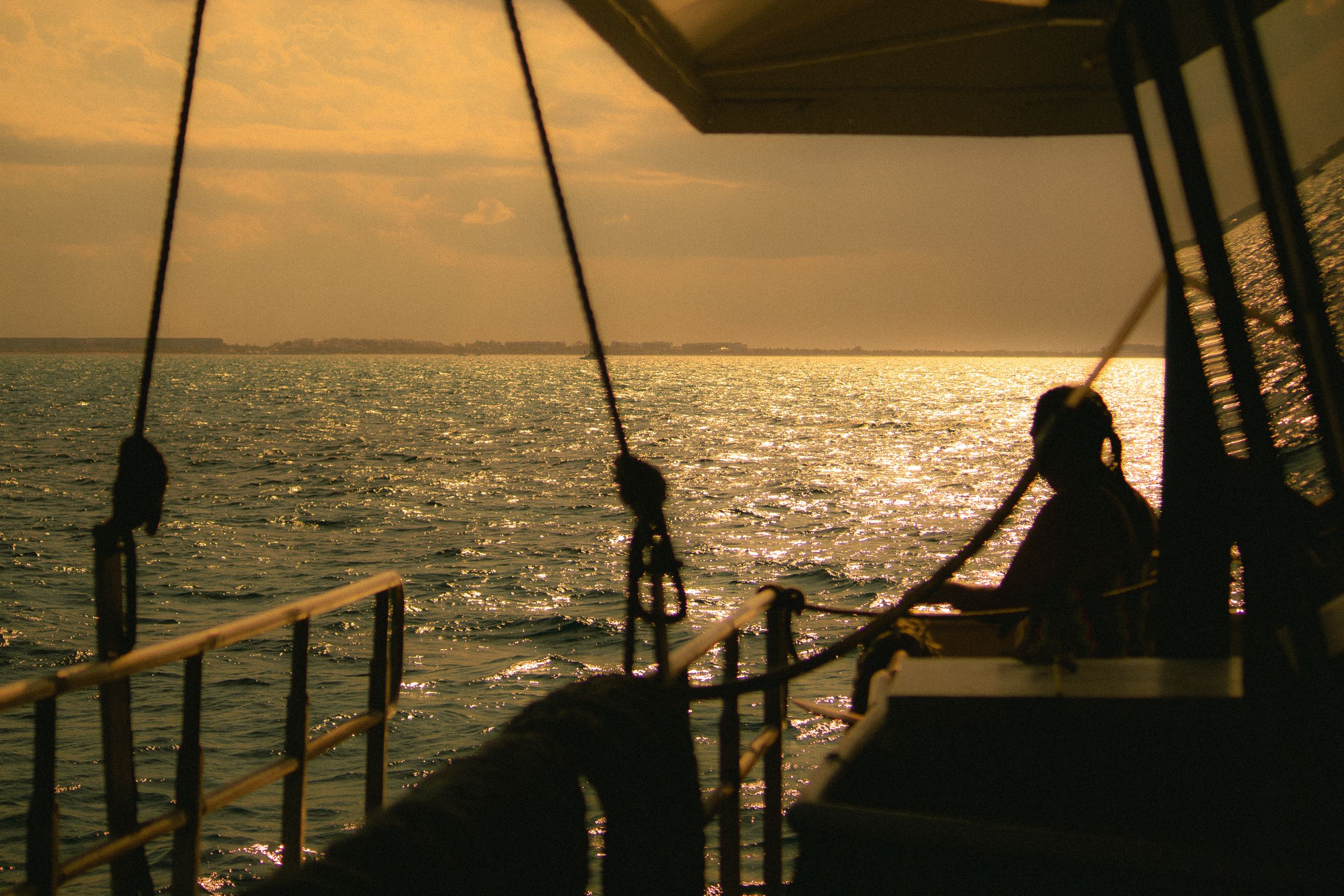 Relaxing Boat Ride on Serene Ocean at Sunset · Free Stock Photo
