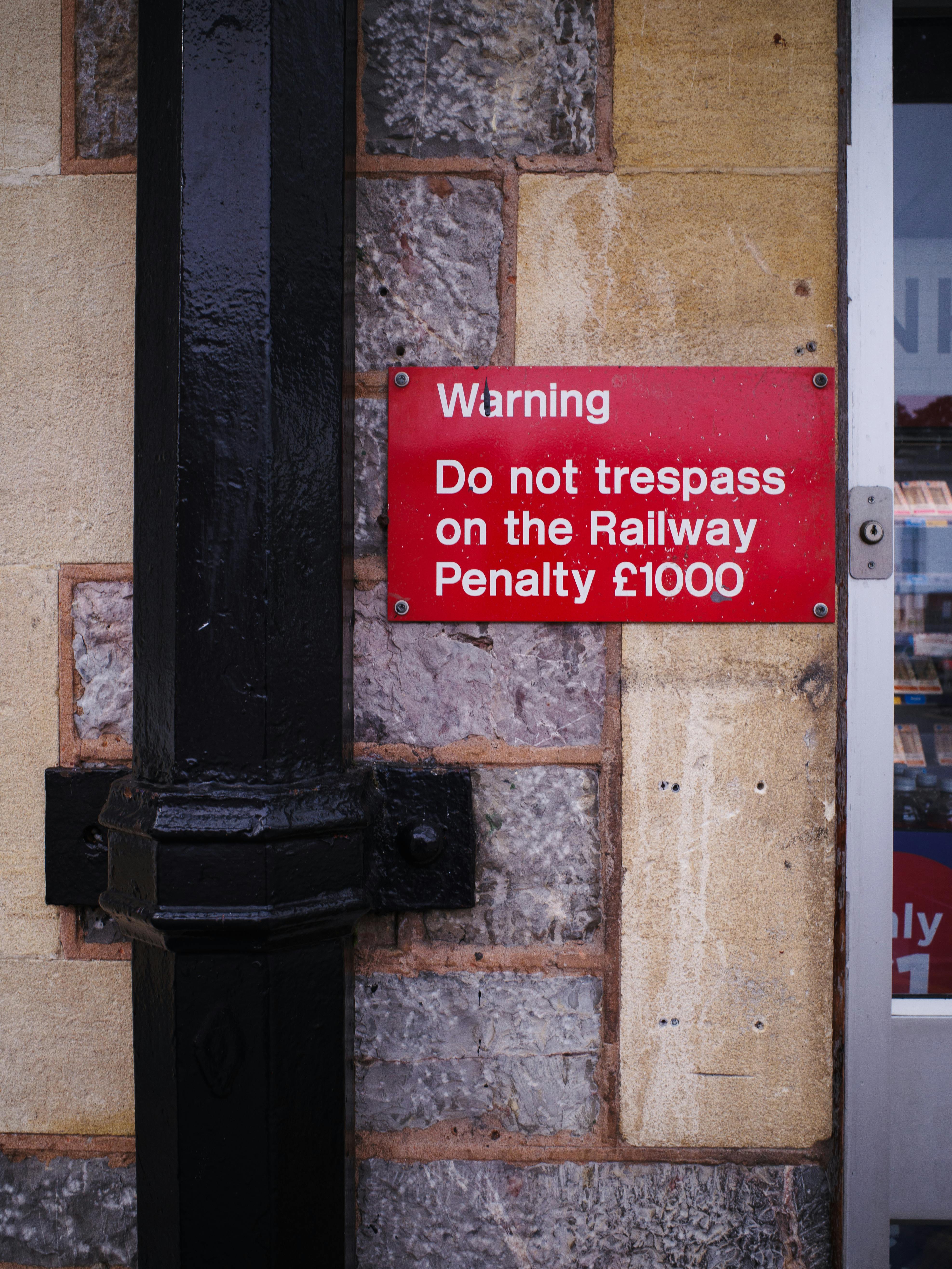 Railway Trespassing Warning Sign with Penalty Notice · Free Stock Photo