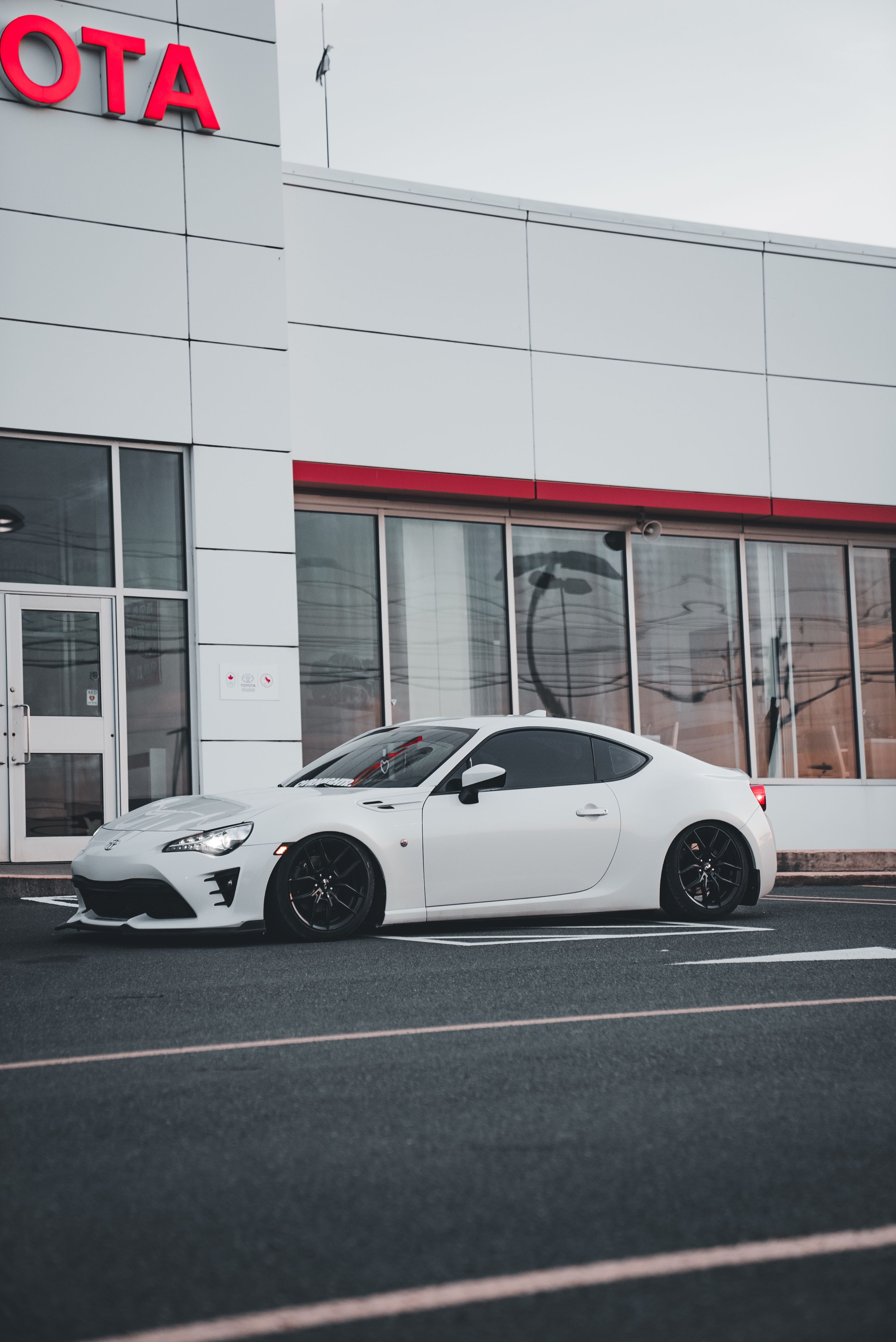 Sleek White Sports Car by Modern Dealership · Free Stock Photo