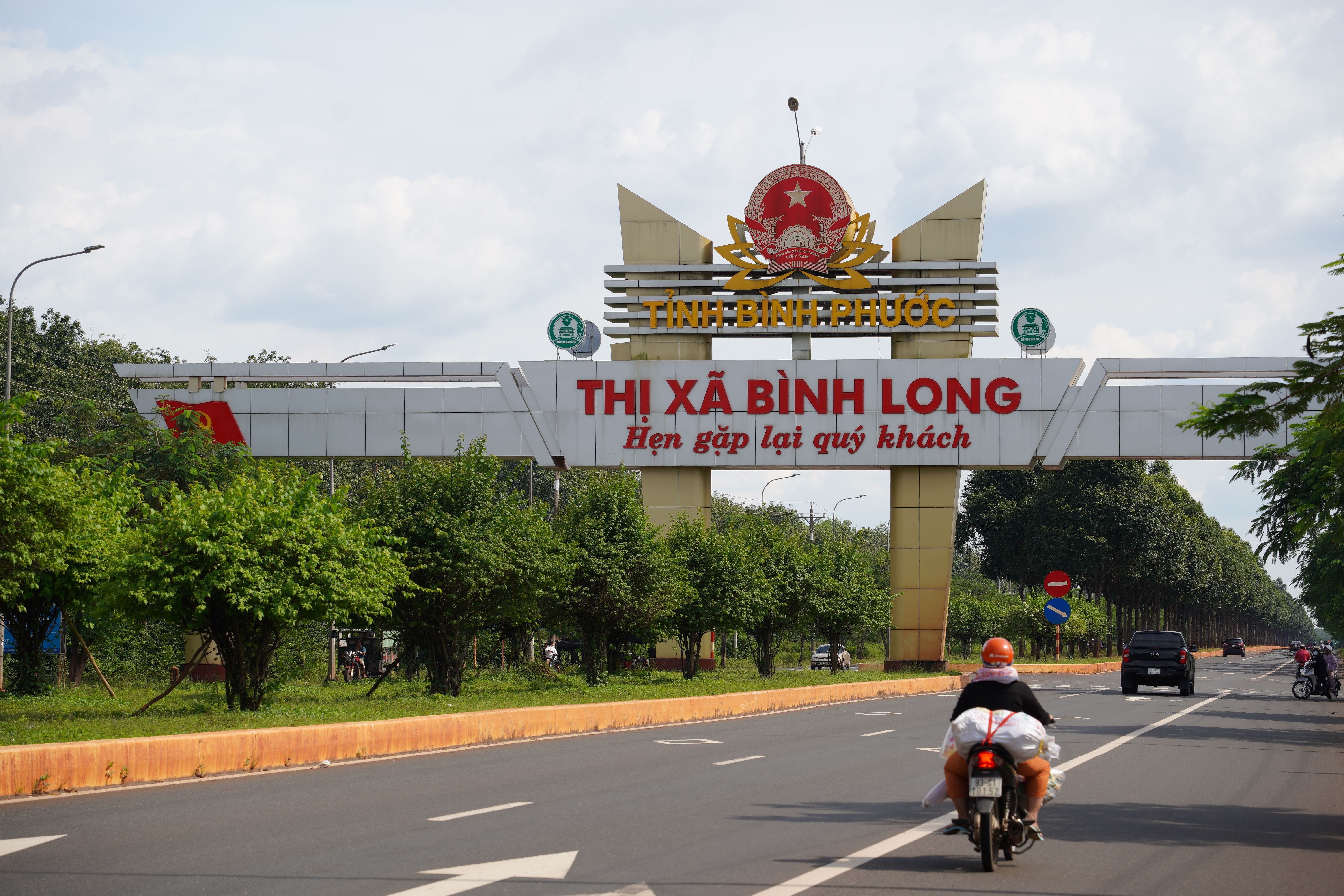 Motorcyclist Approaching Binh Long Gate in Vietnam · Free Stock Photo
