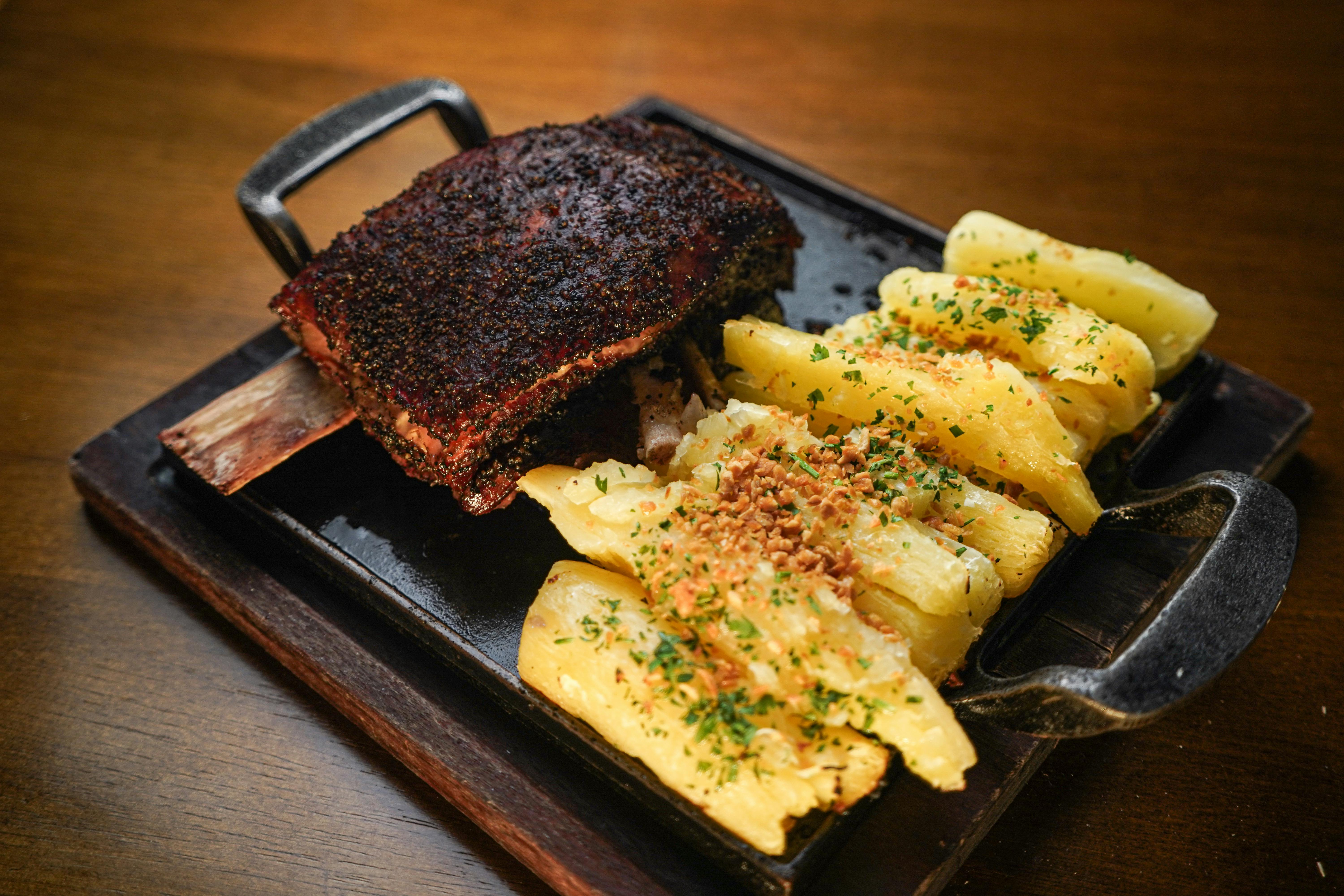 Delicious Roasted Beef Ribs with Seasoned Potatoes · Free Stock Photo