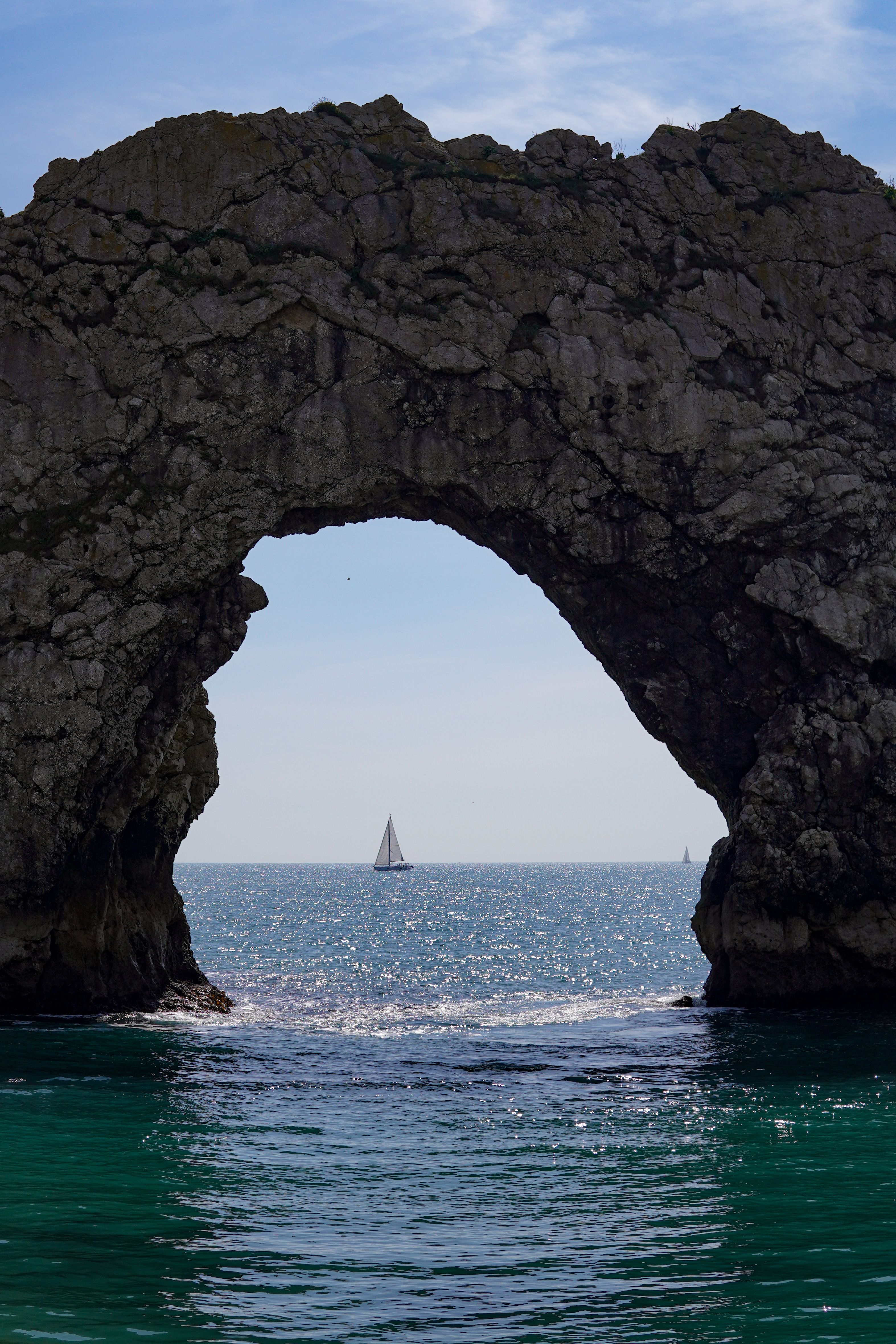 Sailboat Viewed Through Durdle Door Arch in Dorset · Free Stock Photo