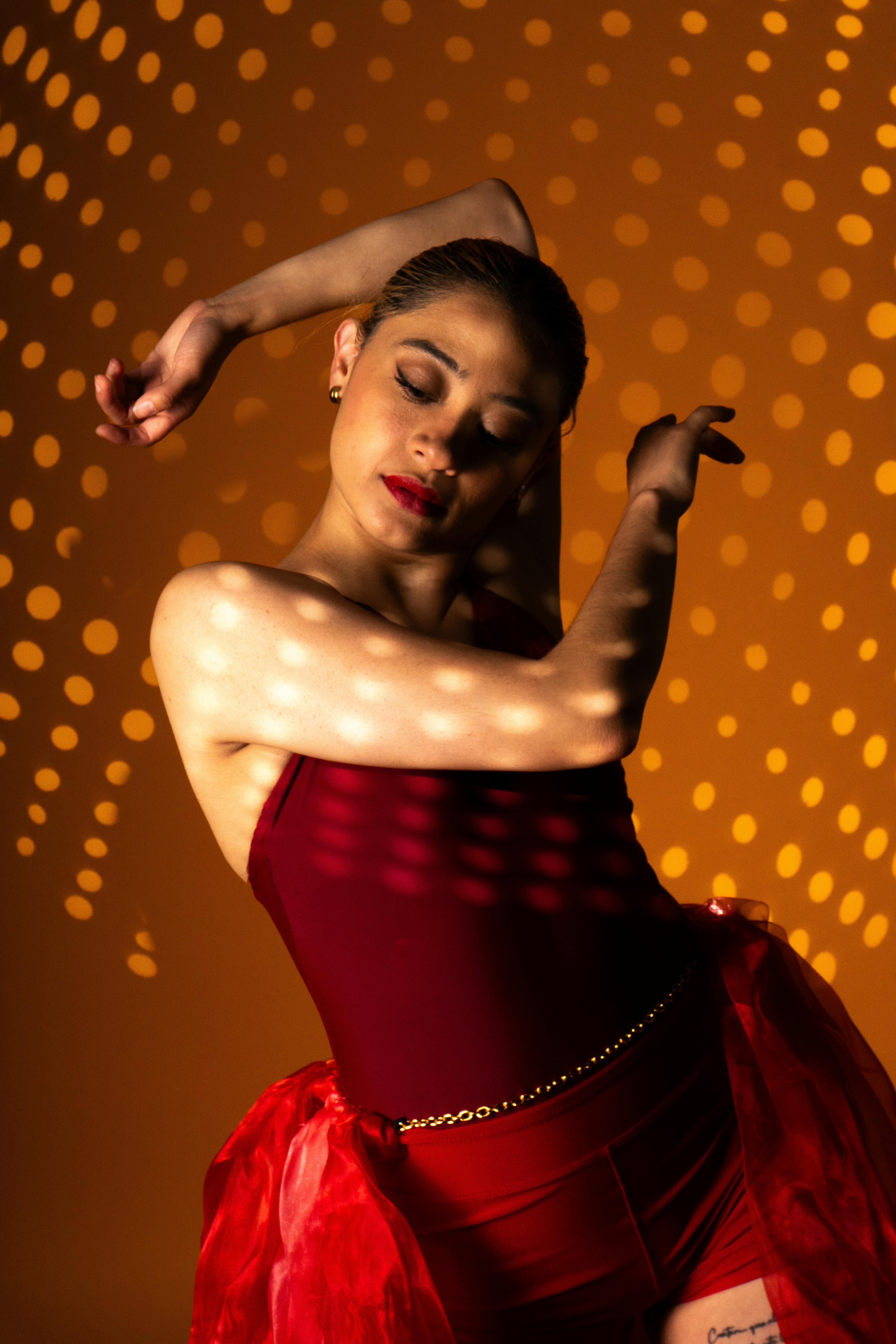Elegant Latina Dancer in Red Spotlight · Free Stock Photo