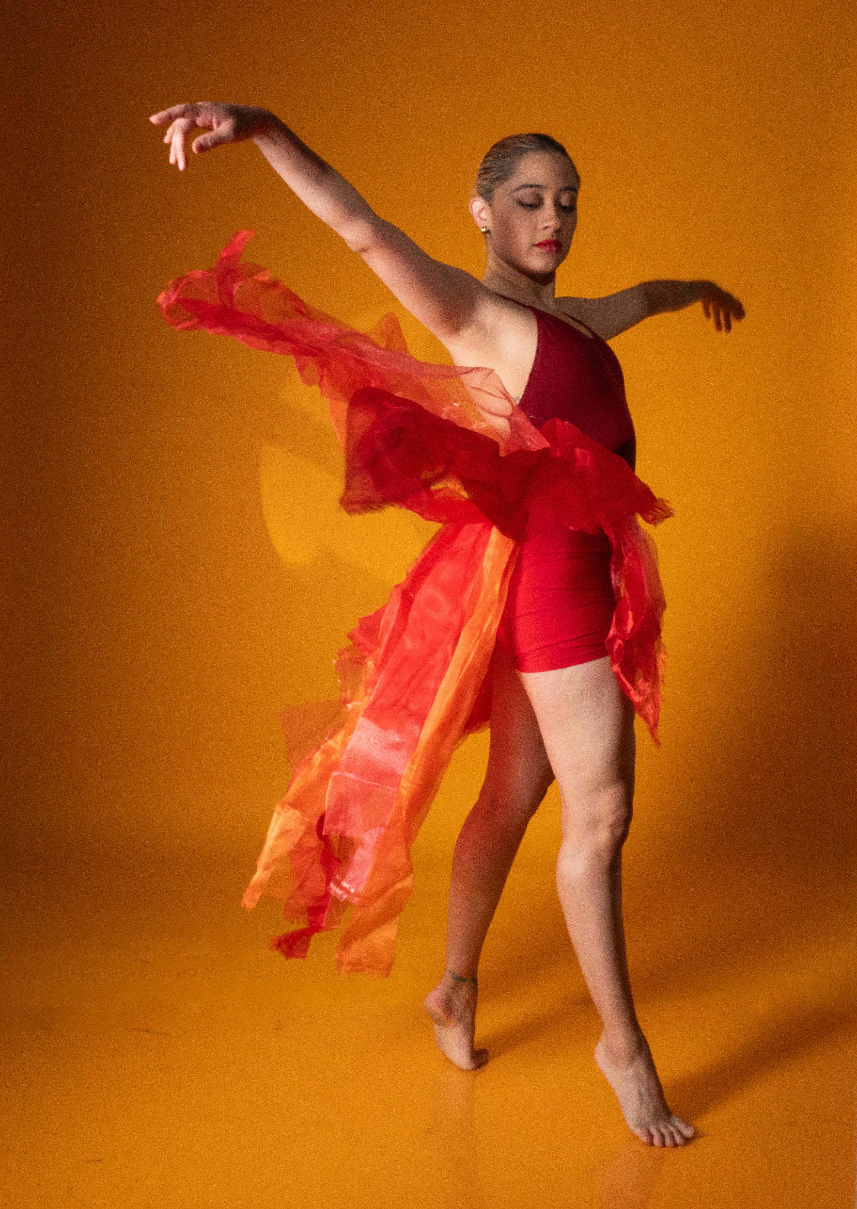 Graceful Ballet Dance in Vibrant Red and Orange · Free Stock Photo