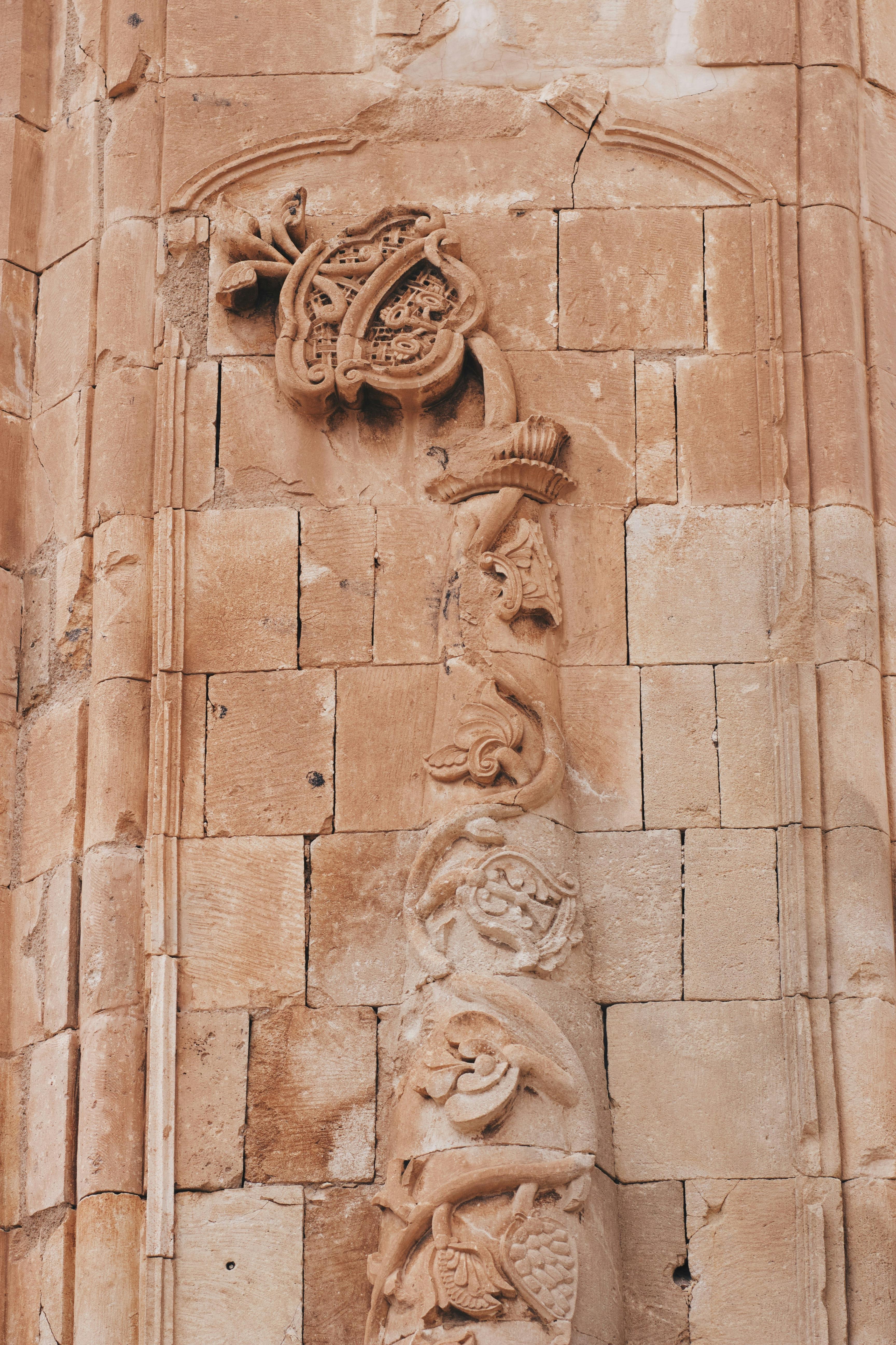 Intricate Historical Stone Carving on Ancient Wall · Free Stock Photo