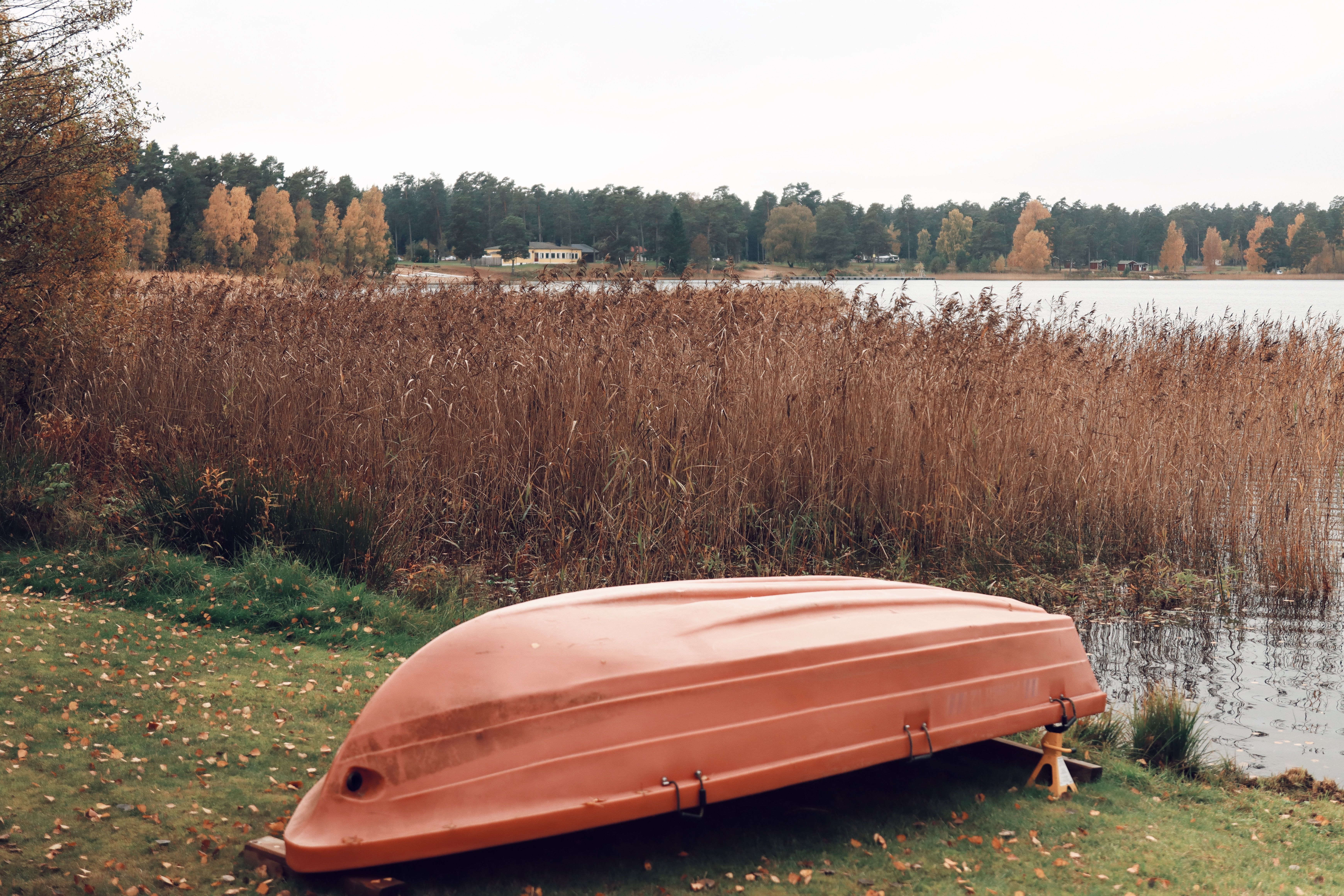 Autumn Lakeside View with an Upside Down Boat · Free Stock Photo