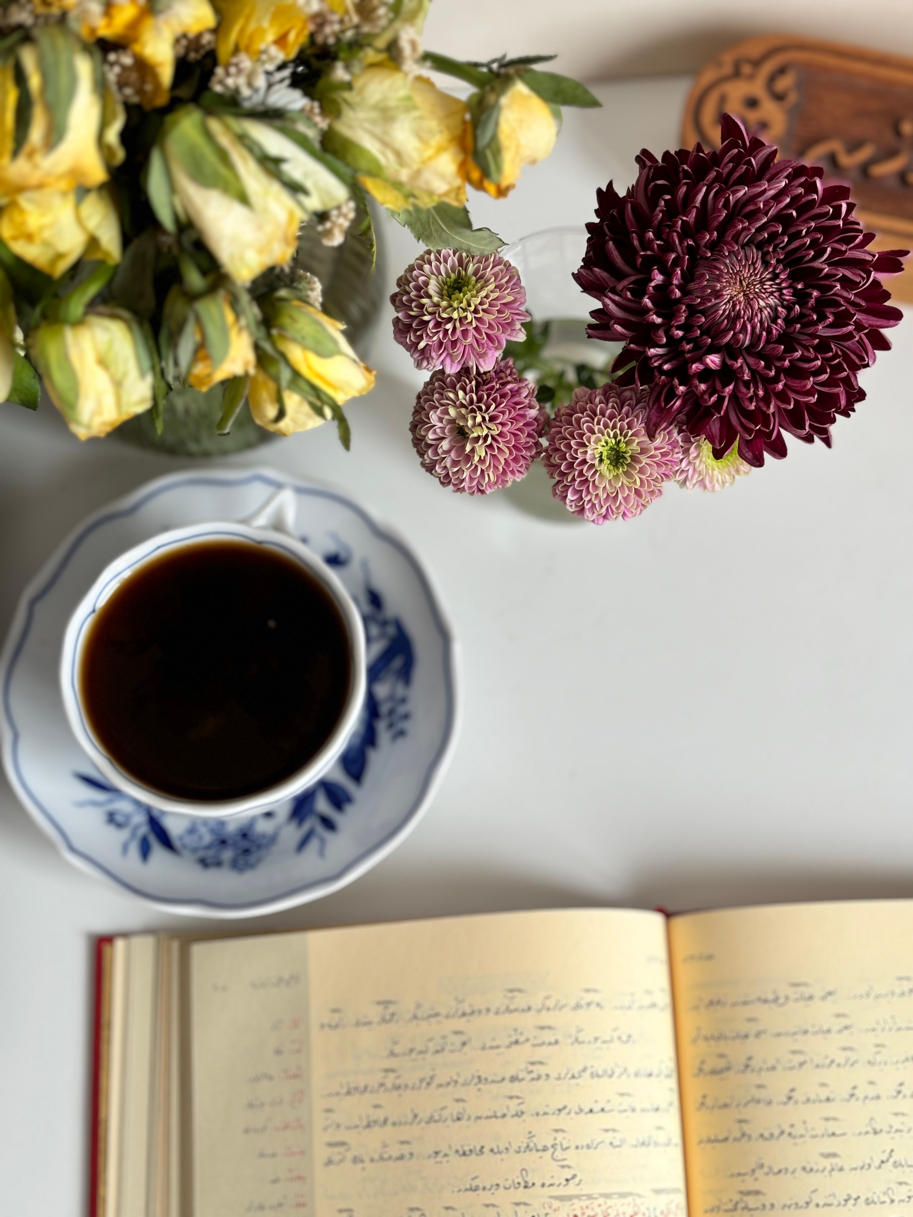 Cozy Reading Scene with Flowers and Coffee · Free Stock Photo