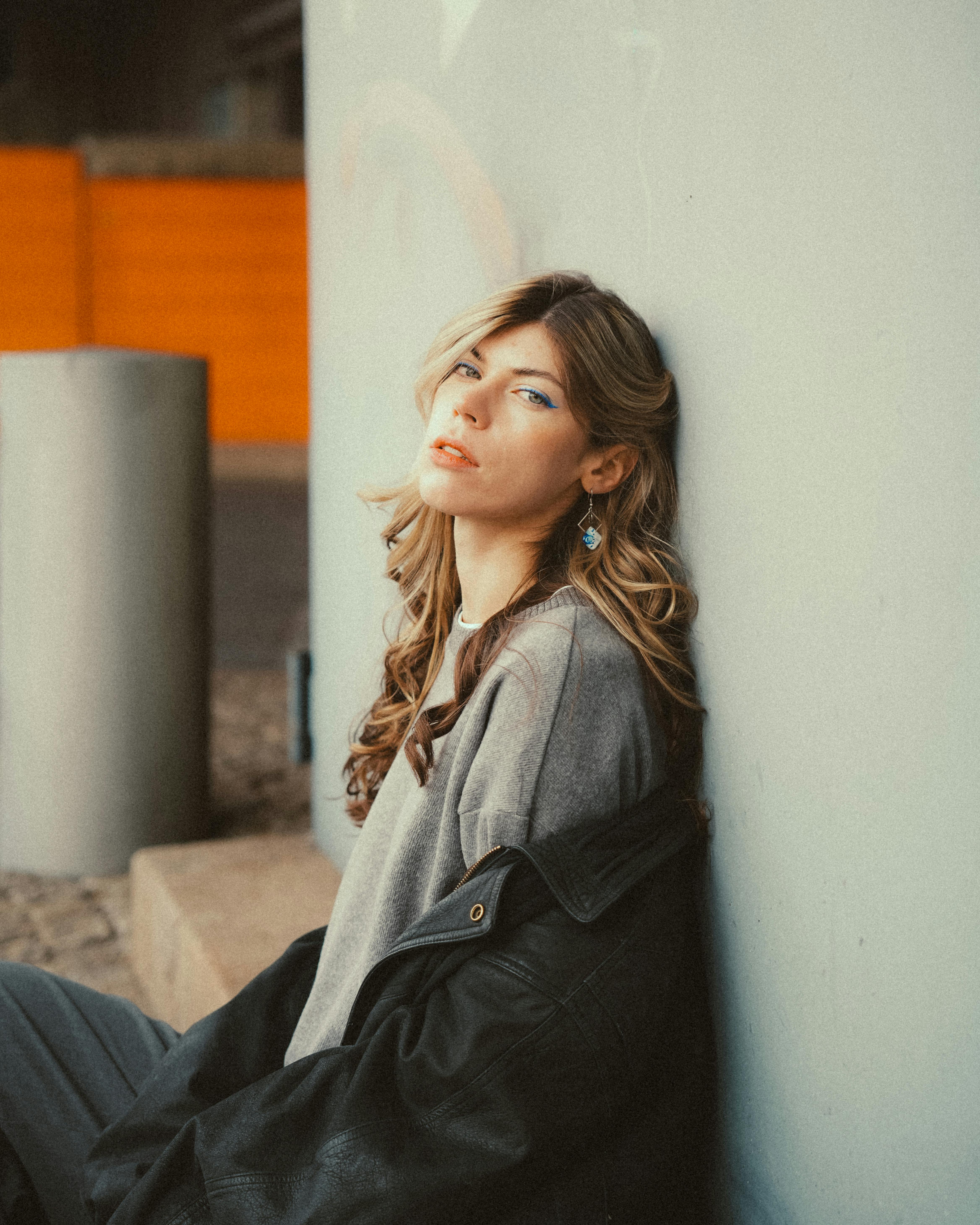 Chic Young Woman Posing Against Urban Backdrop · Free Stock Photo