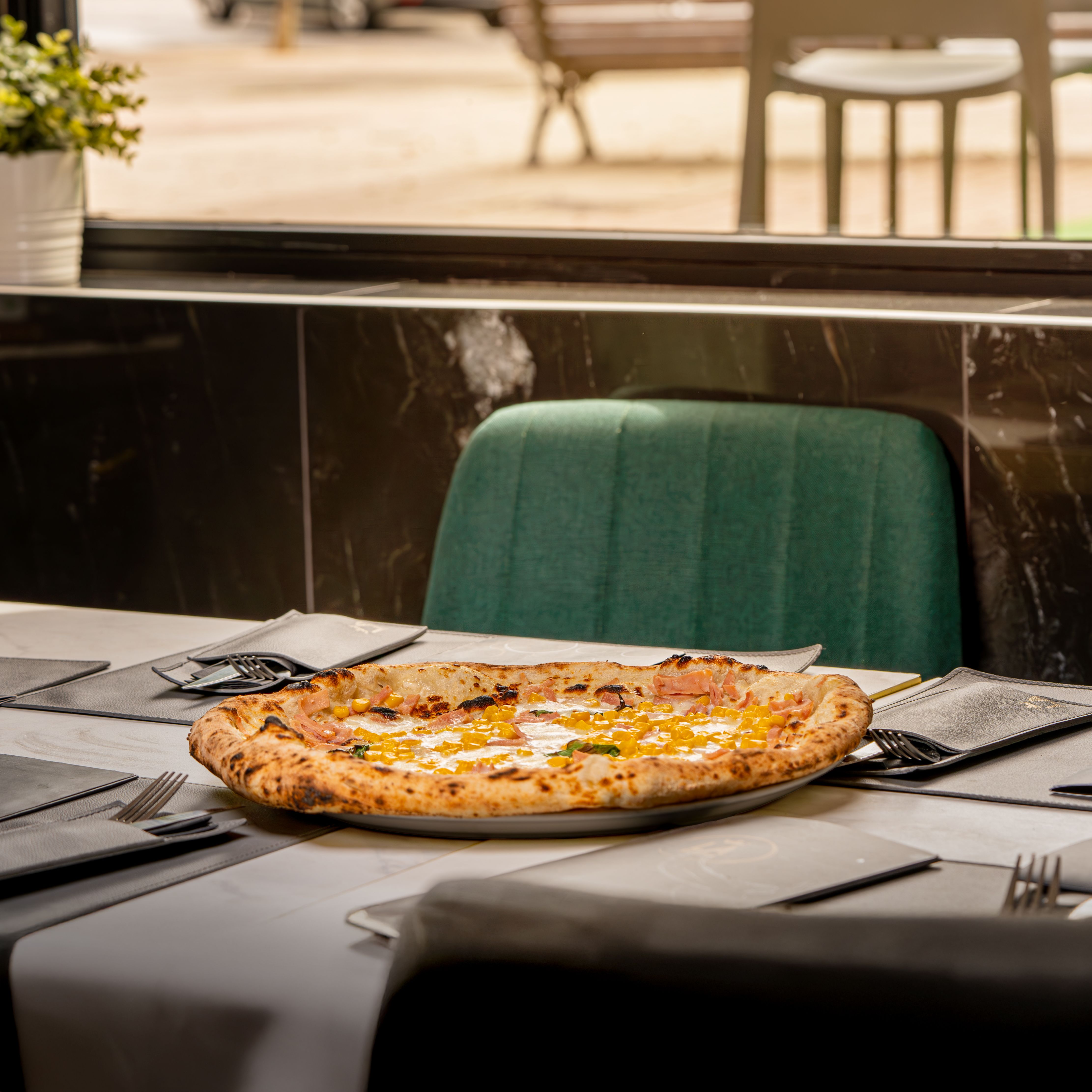 Delicious Pepperoni Pizza in Modern Cafe Setting · Free Stock Photo