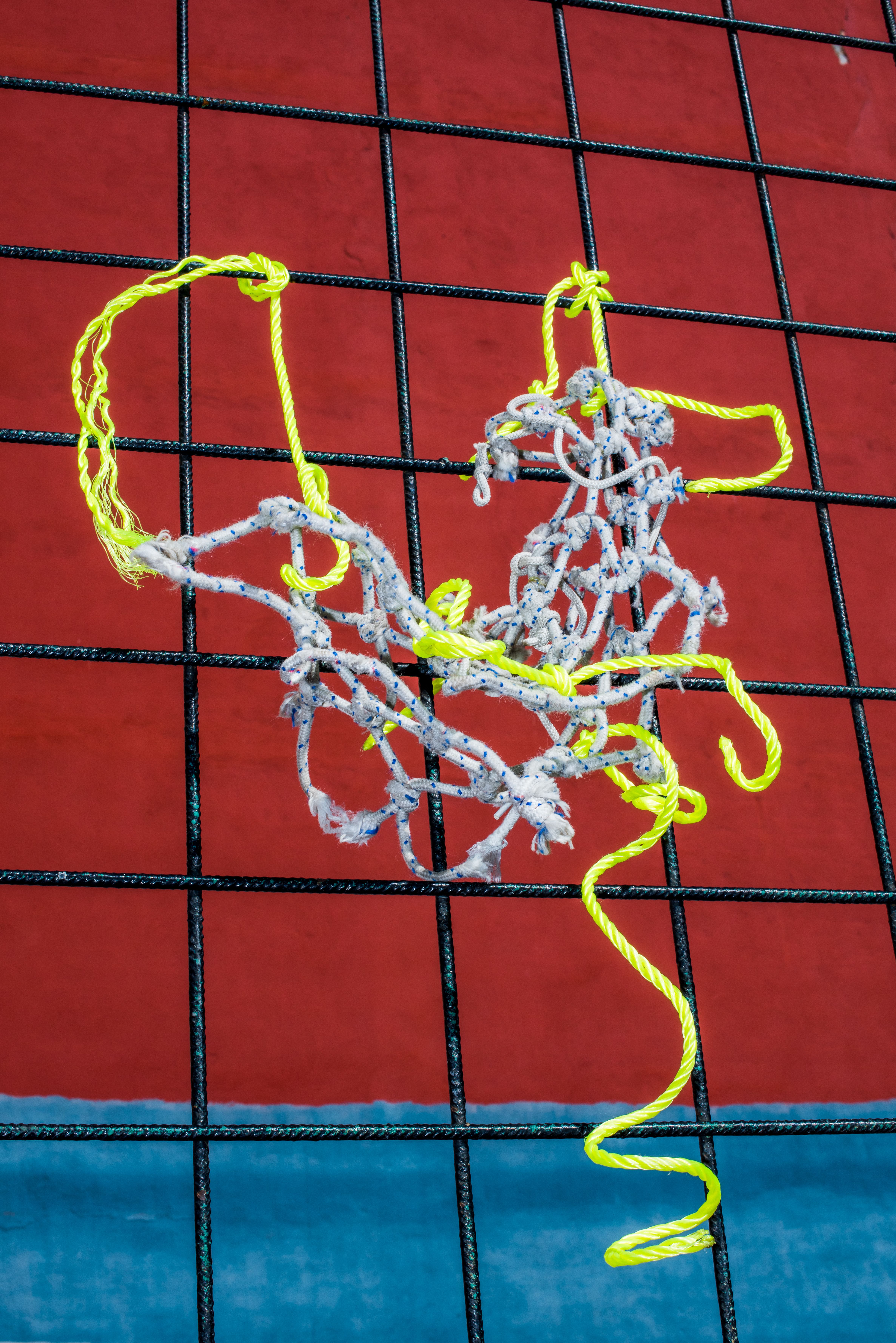 Abstract Colorful Rope Art on Gridded Wall · Free Stock Photo