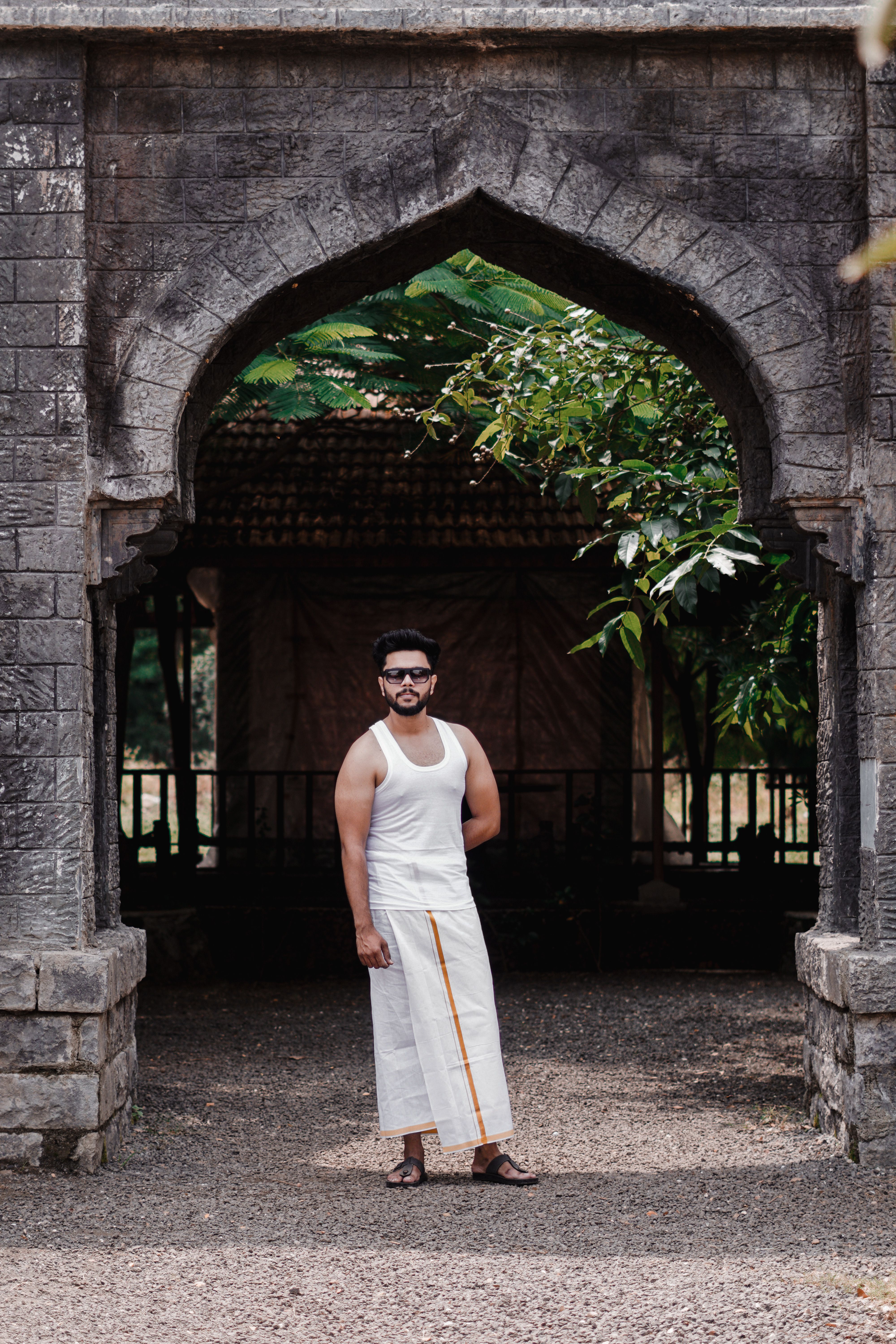 Indian Man in Traditional Attire at Ancient Stone Archway · Free Stock ...