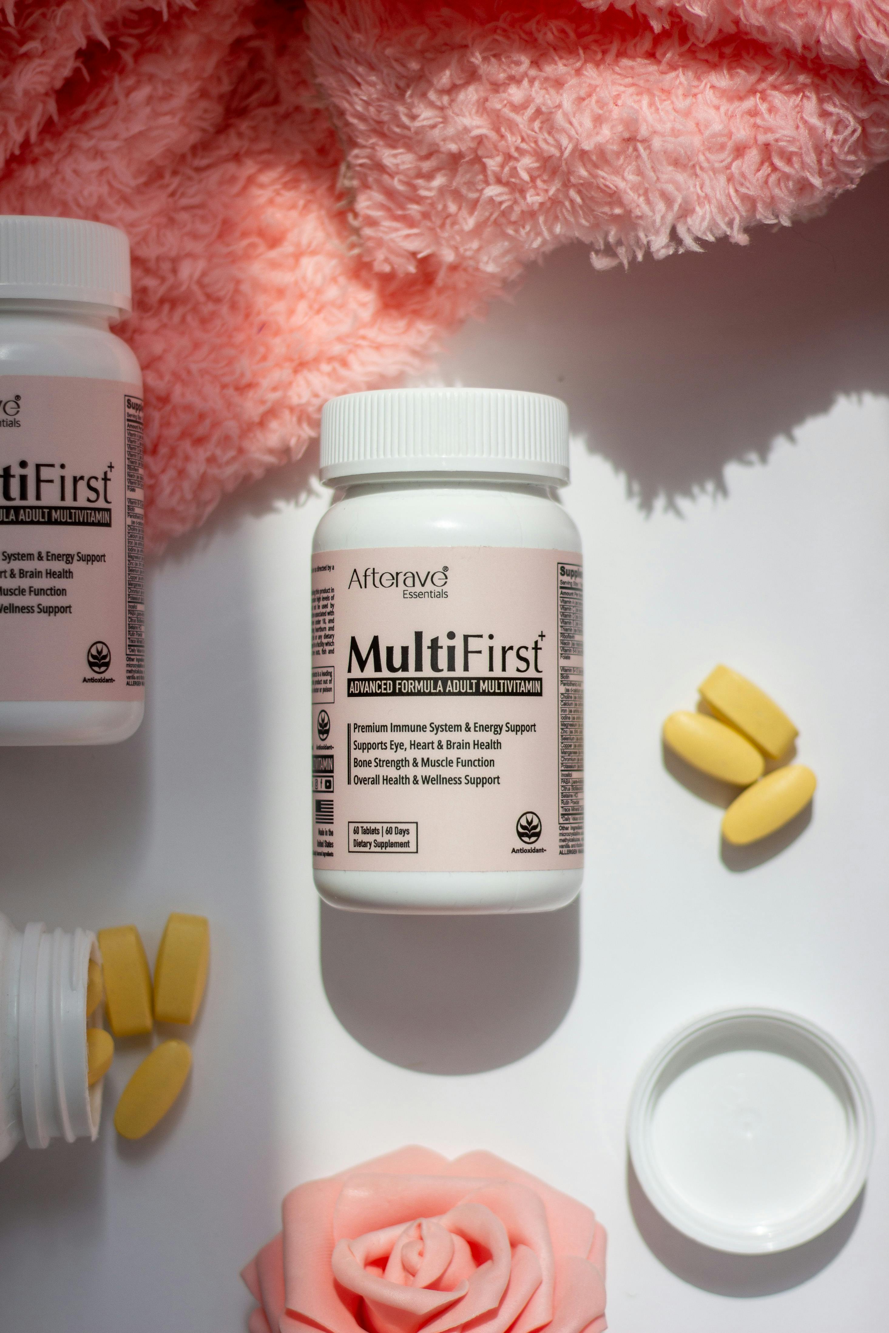 Multivitamin Bottle and Pills on White Surface · Free Stock Photo