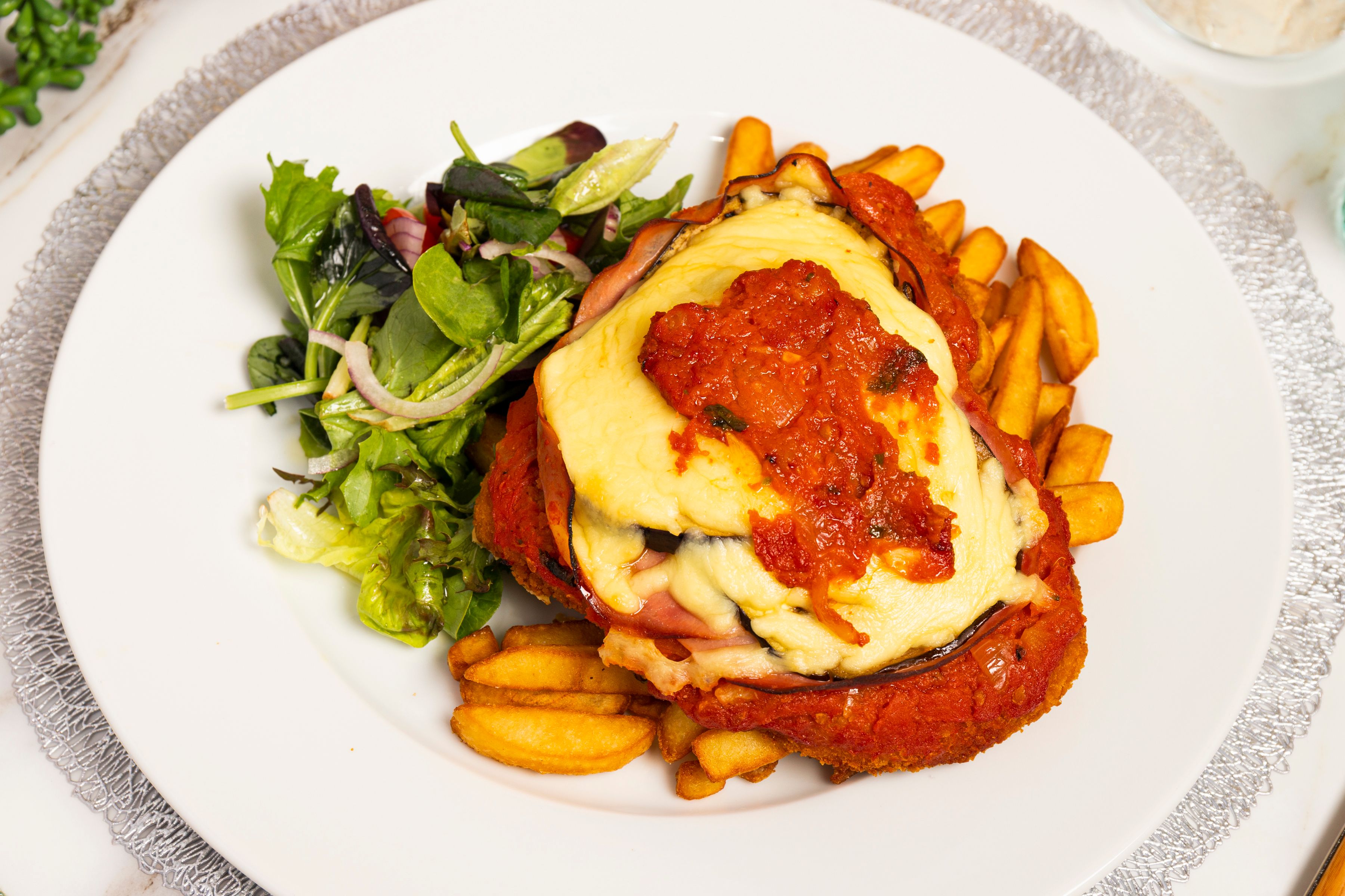Gourmet Chicken Parmigiana with Chips and Salad · Free Stock Photo