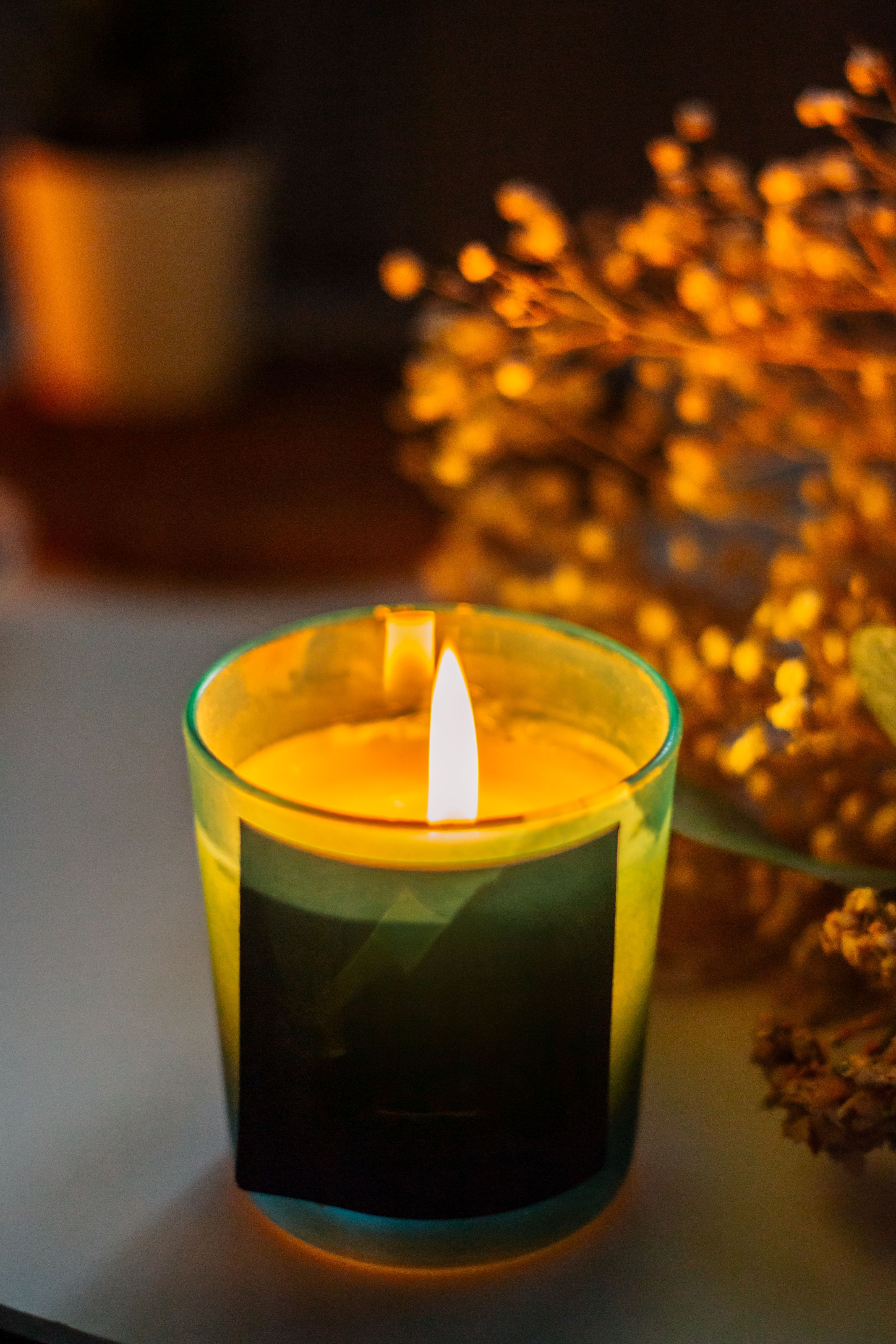 Warm Glow Candle with Golden Decor · Free Stock Photo