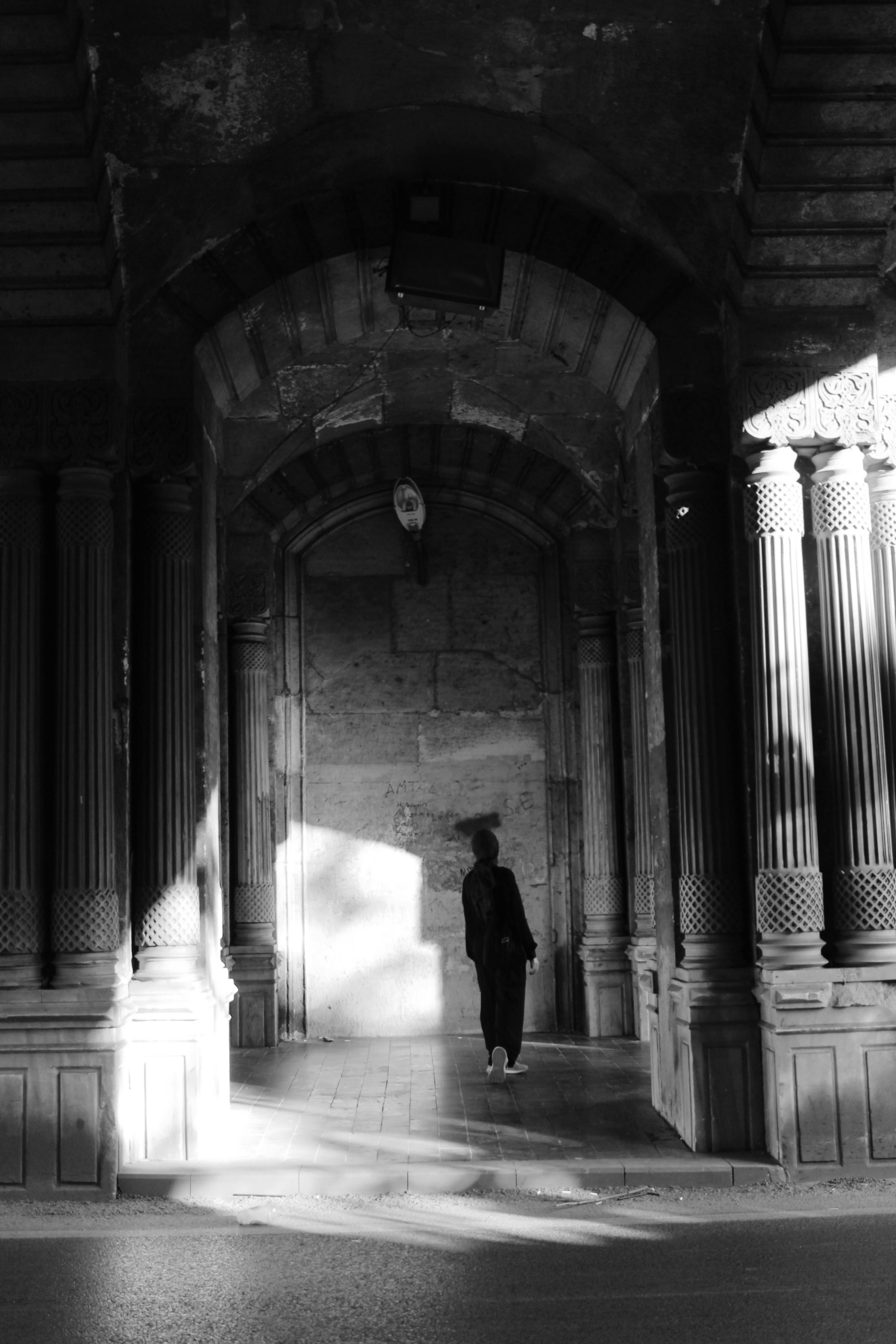 Silhouette in Historic Archway with Dramatic Shadows · Free Stock Photo
