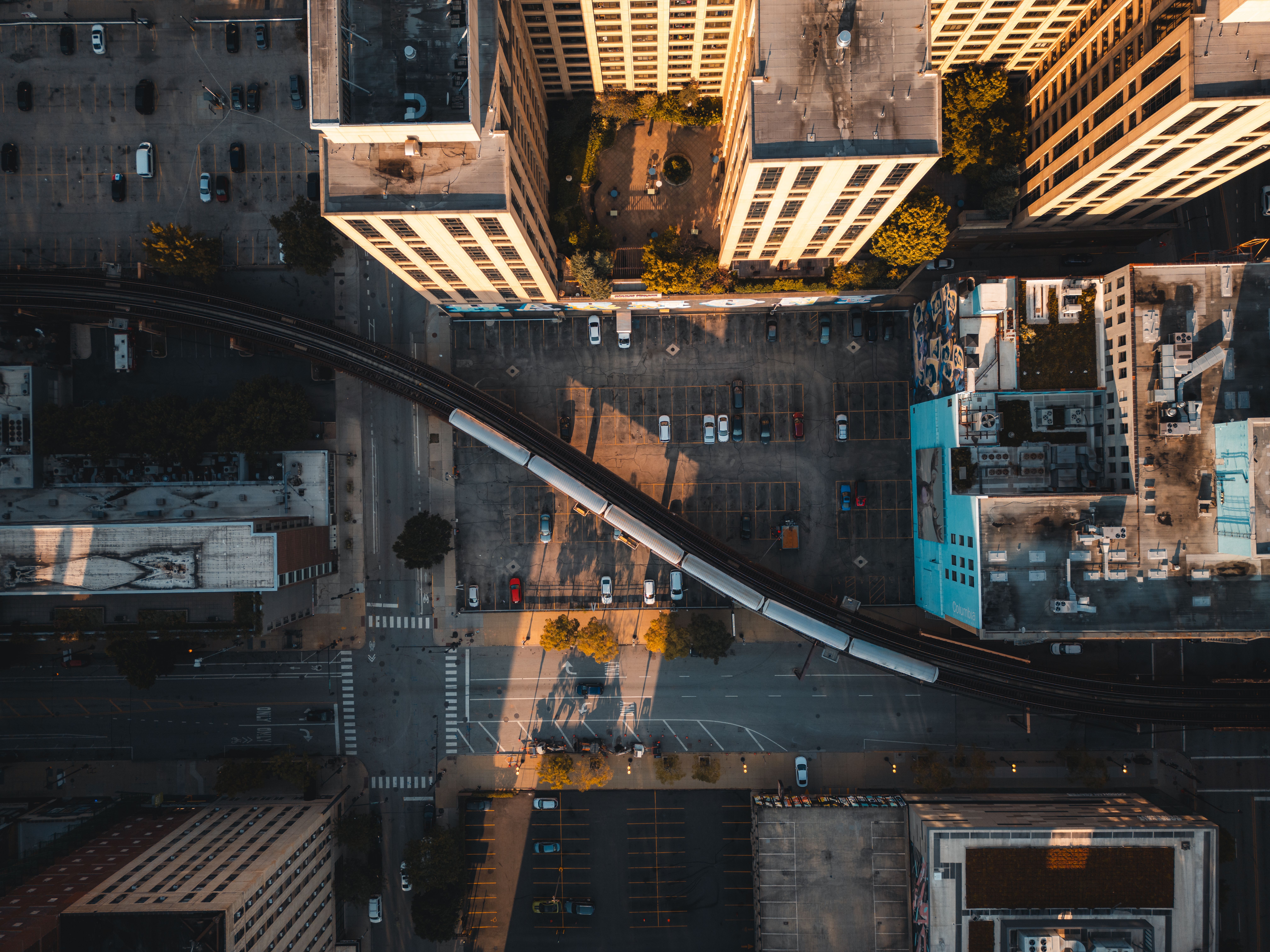 Aerial View of Urban Train Passing through Cityscape · Free Stock Photo